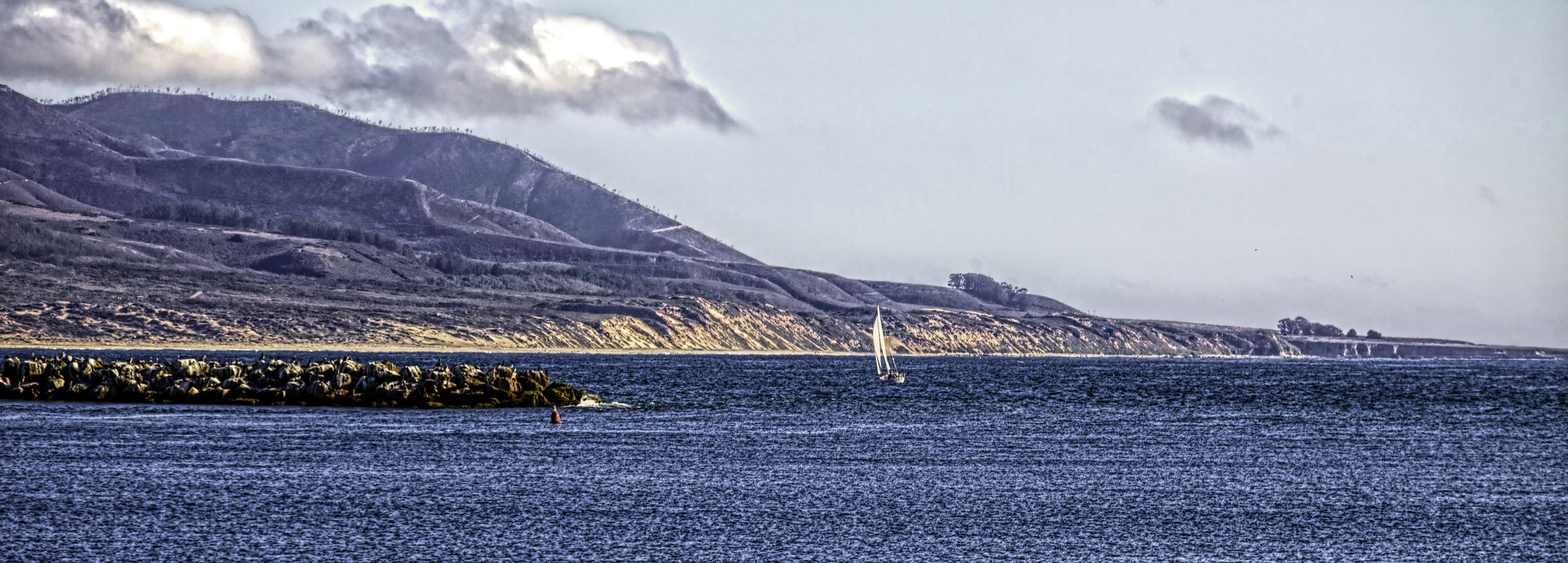 Coastal Ridge and Sail: A Quiet Horizon by the Sea