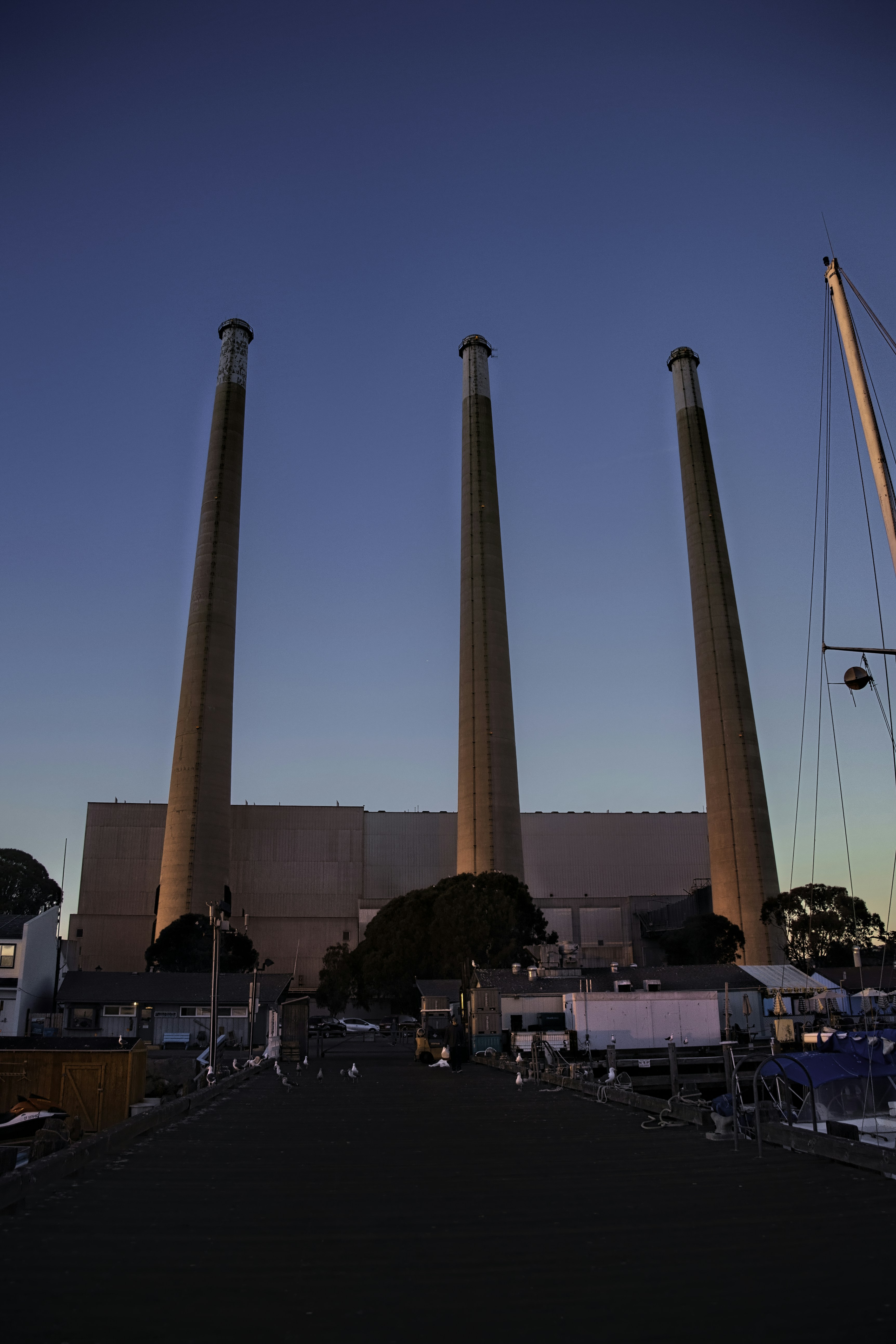 Triple smoke stacks | a couple of tall towers sitting next to each other