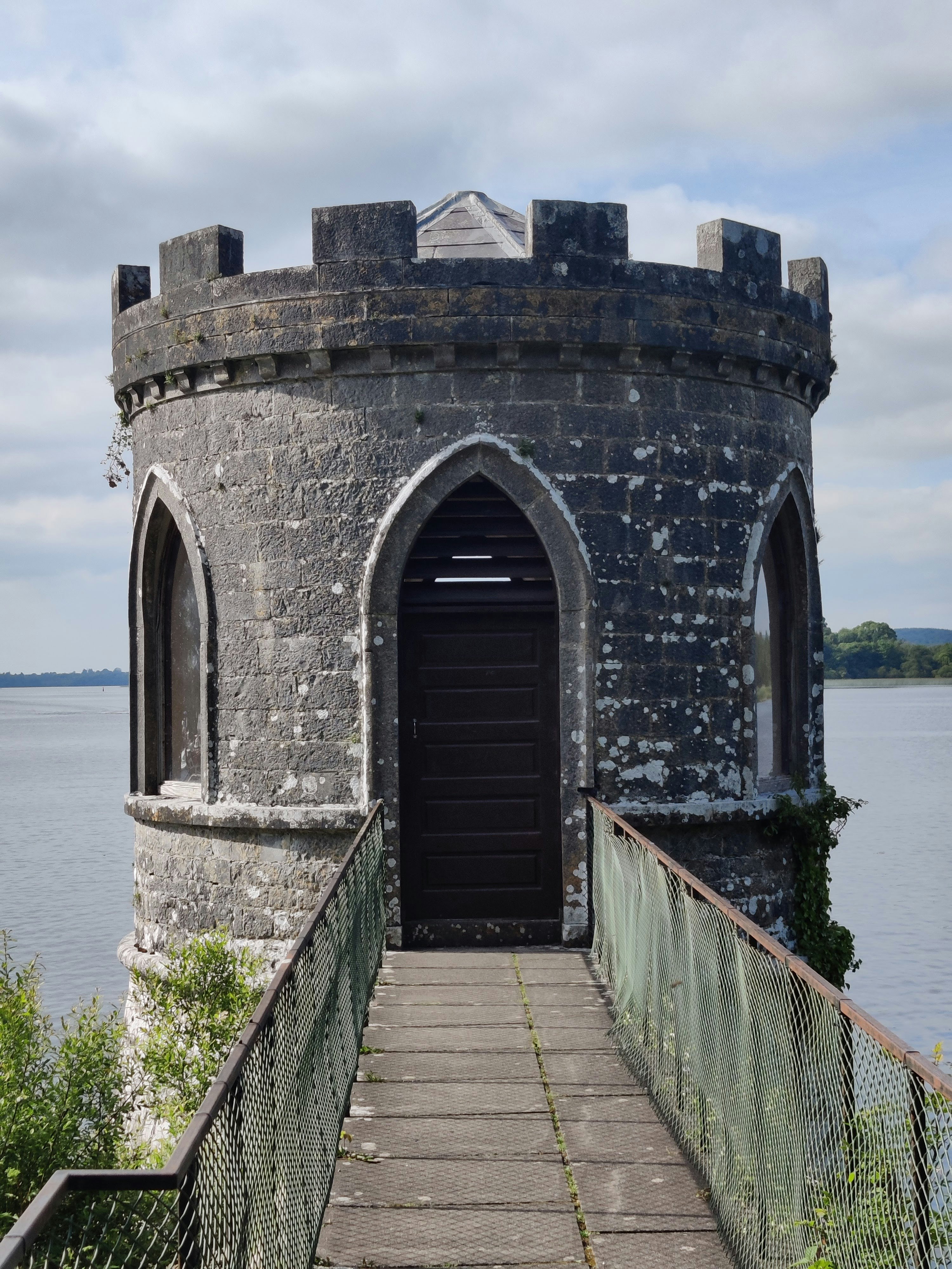 Castle on the Causeway: A Towering View Over the Still Lake