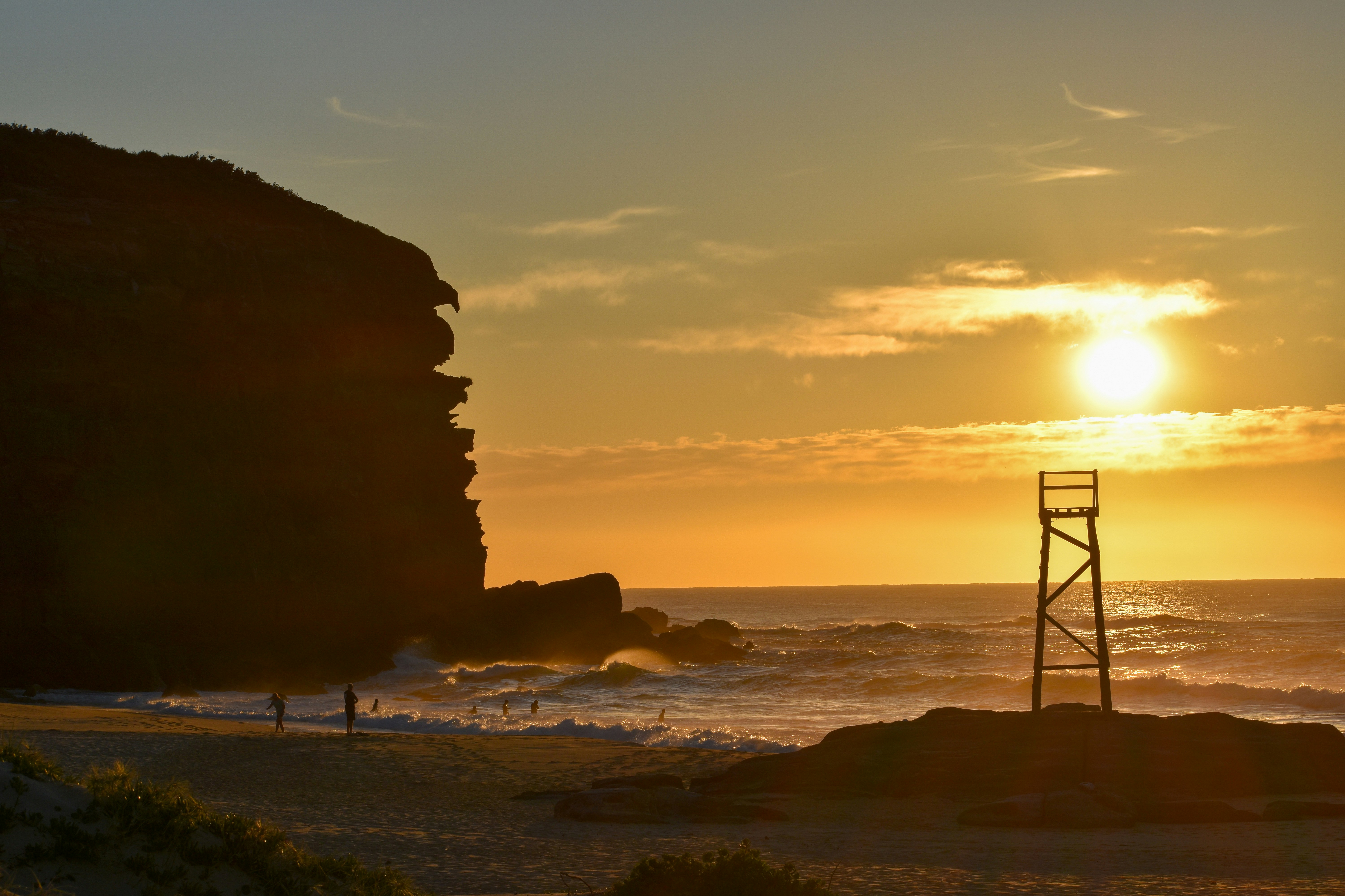 Sunlit Cliffside and Lifeguard Tower at Golden Hour