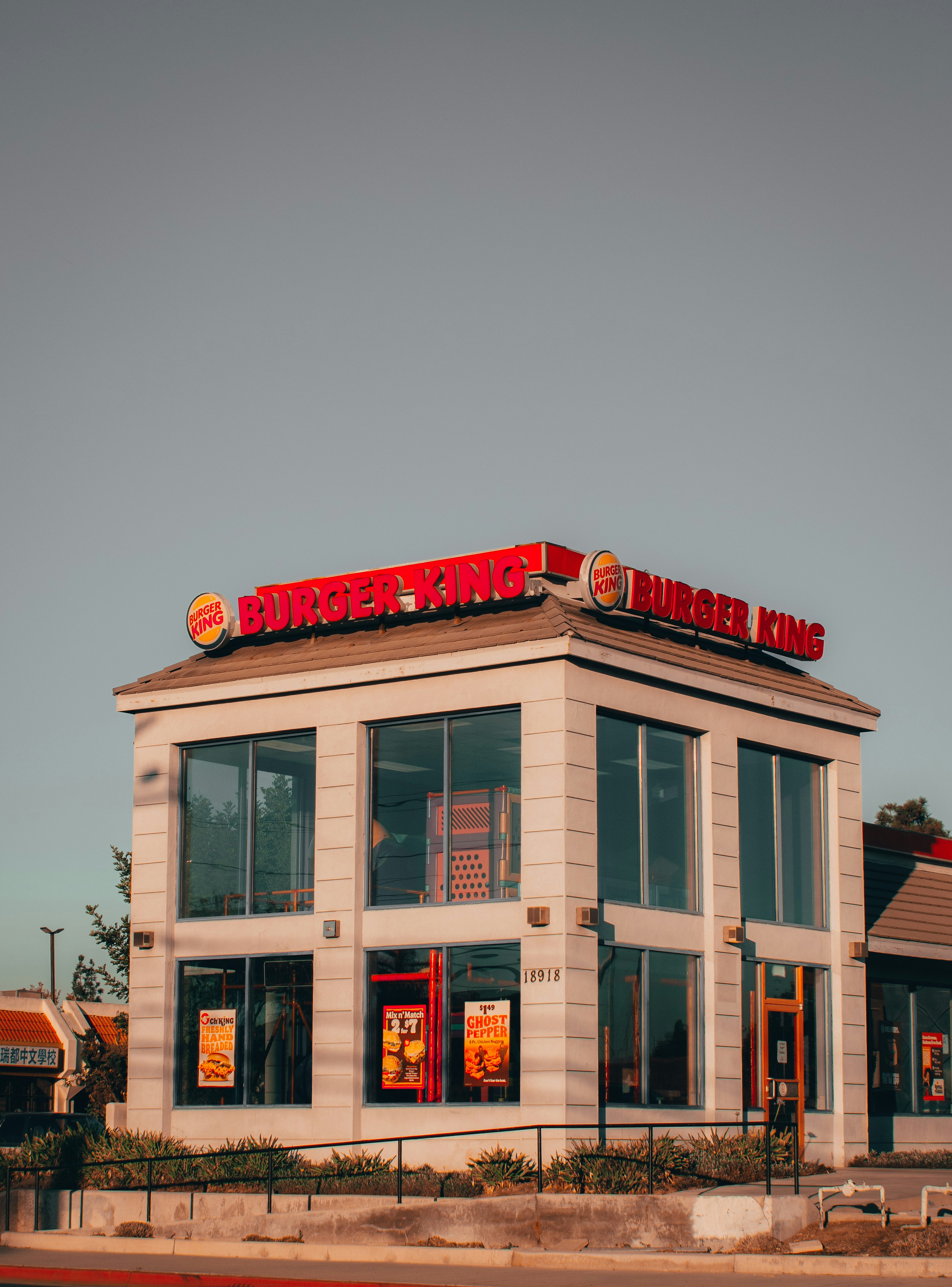 a burger king restaurant on the corner of a street