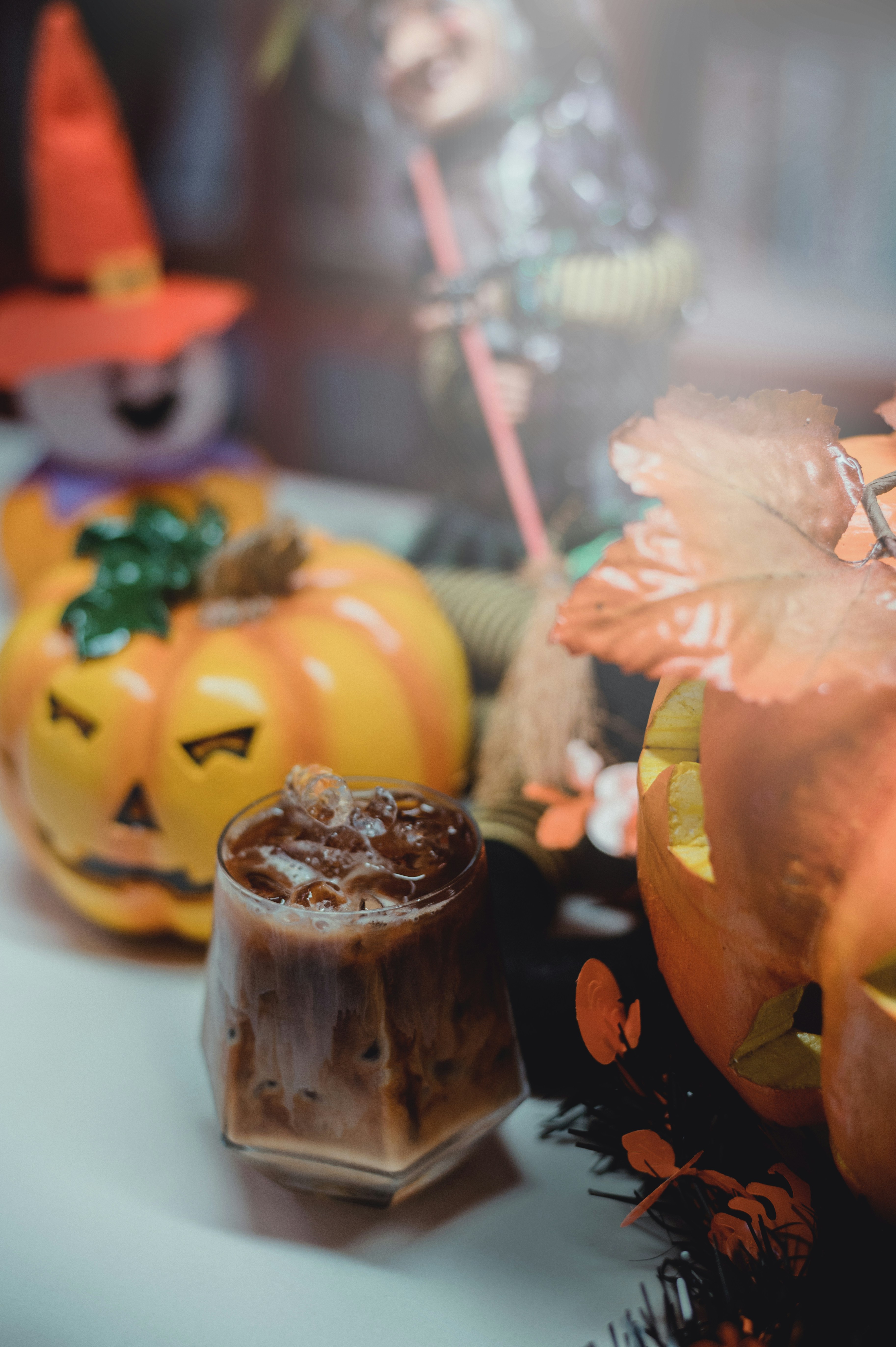 Halloween Spirits: A Glass of Cocoa Amid Jack-o'-Lanterns