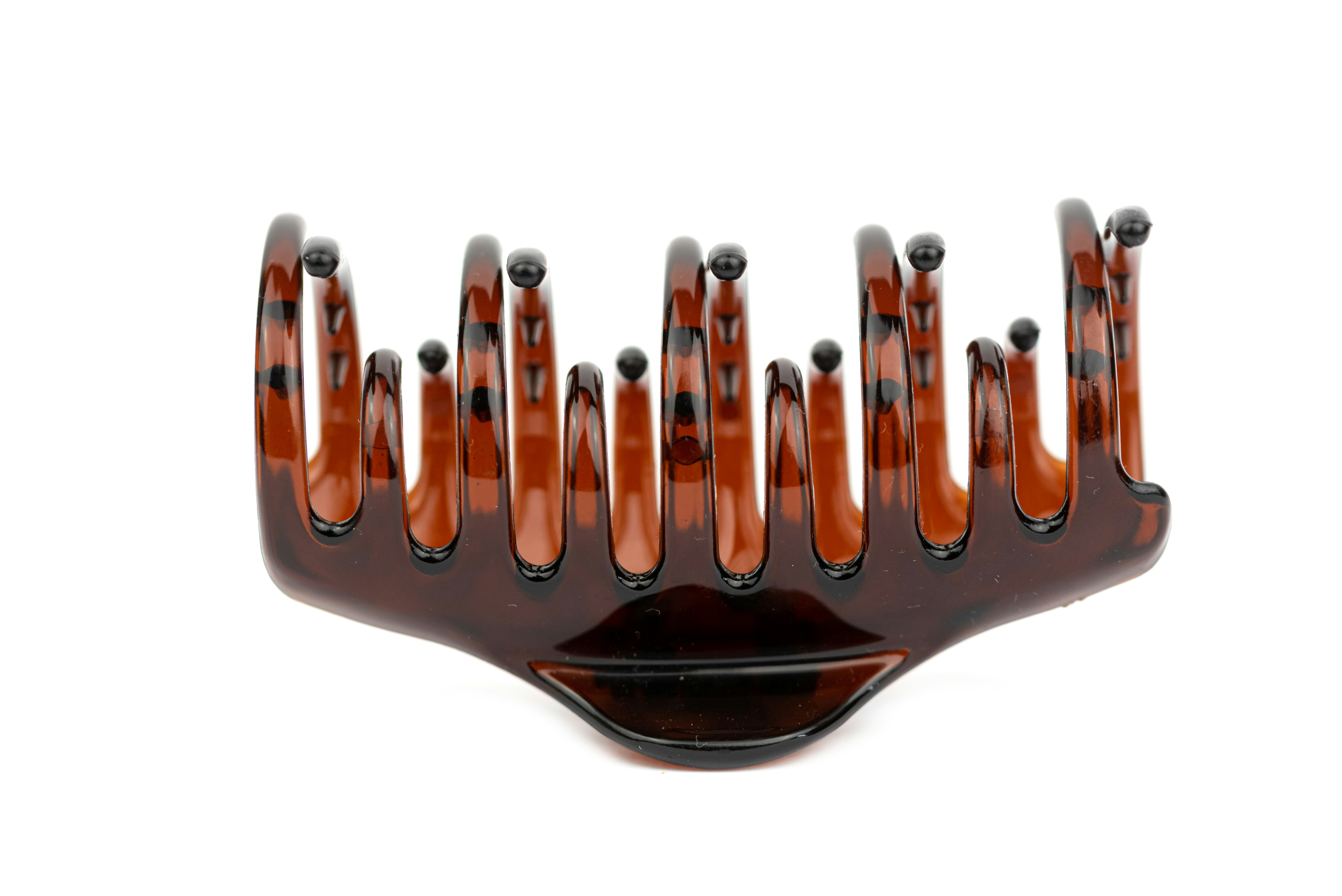A glossy tortoiseshell hair claw with multiple prongs, designed for securing hair in an elegant updo. Ideal for both casual and formal hairstyles.
