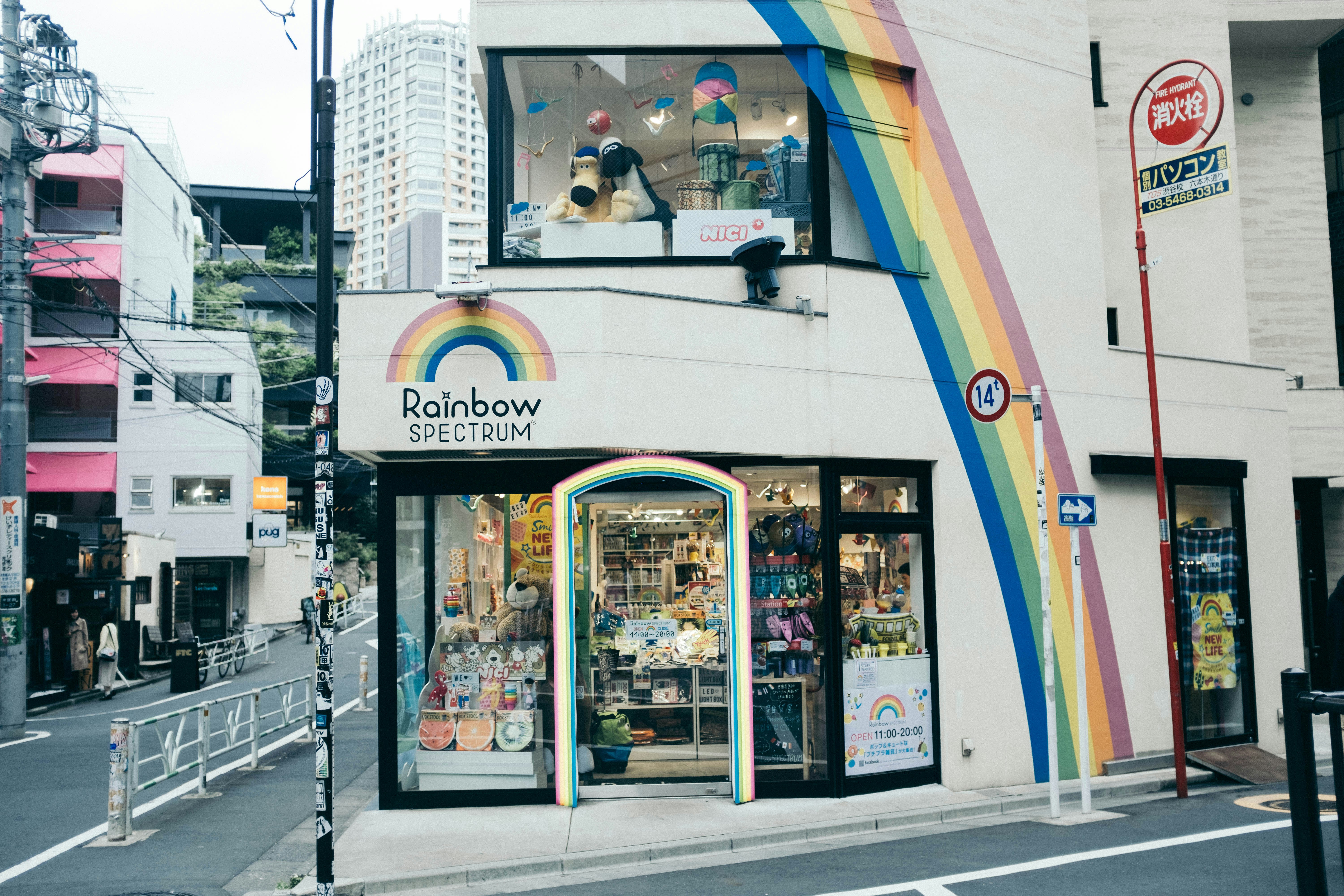 Prismatic Corner: Rainbow Arch Adorns a Bustling Streetfront
