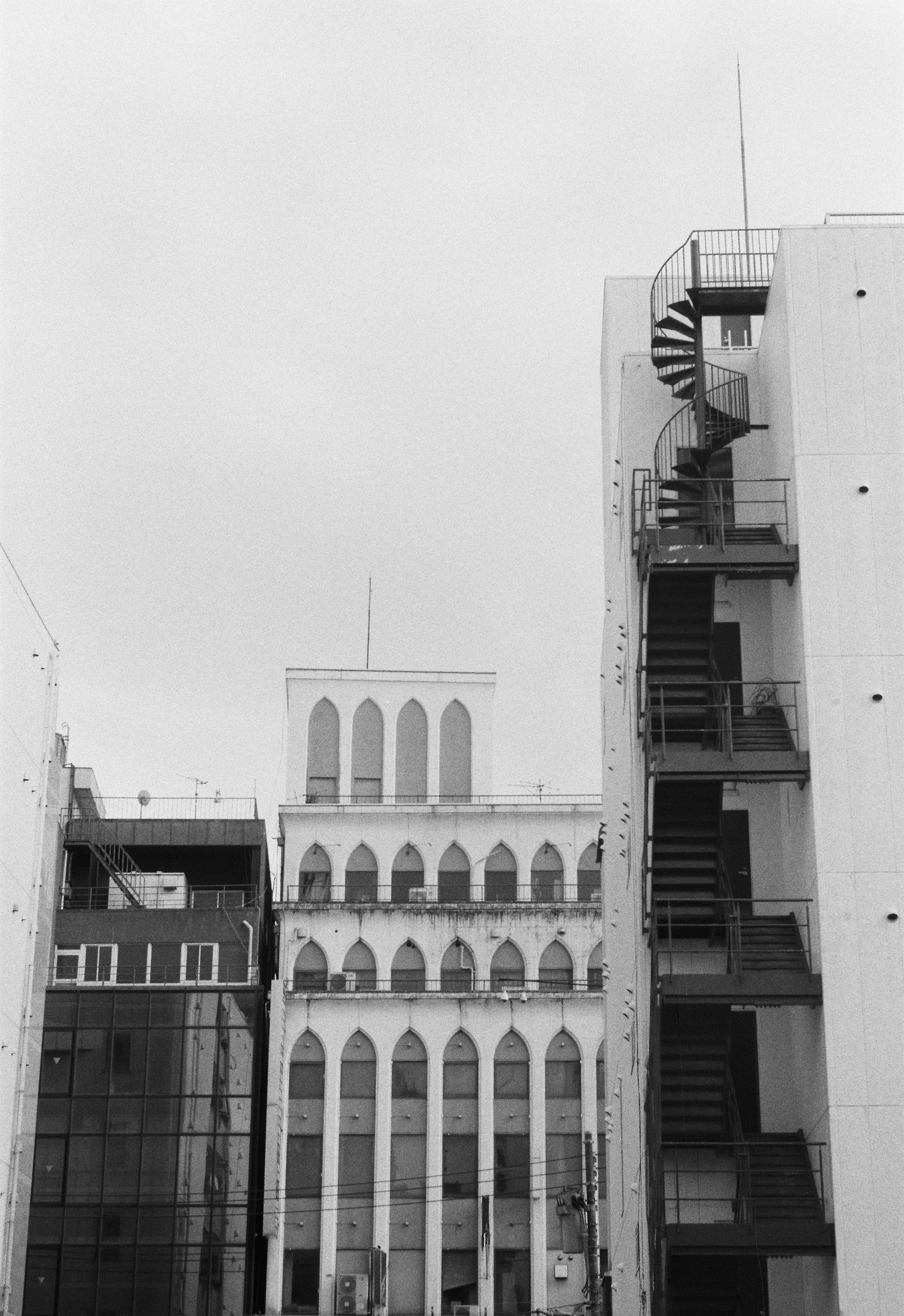 a black and white photo of a building with a fire escape