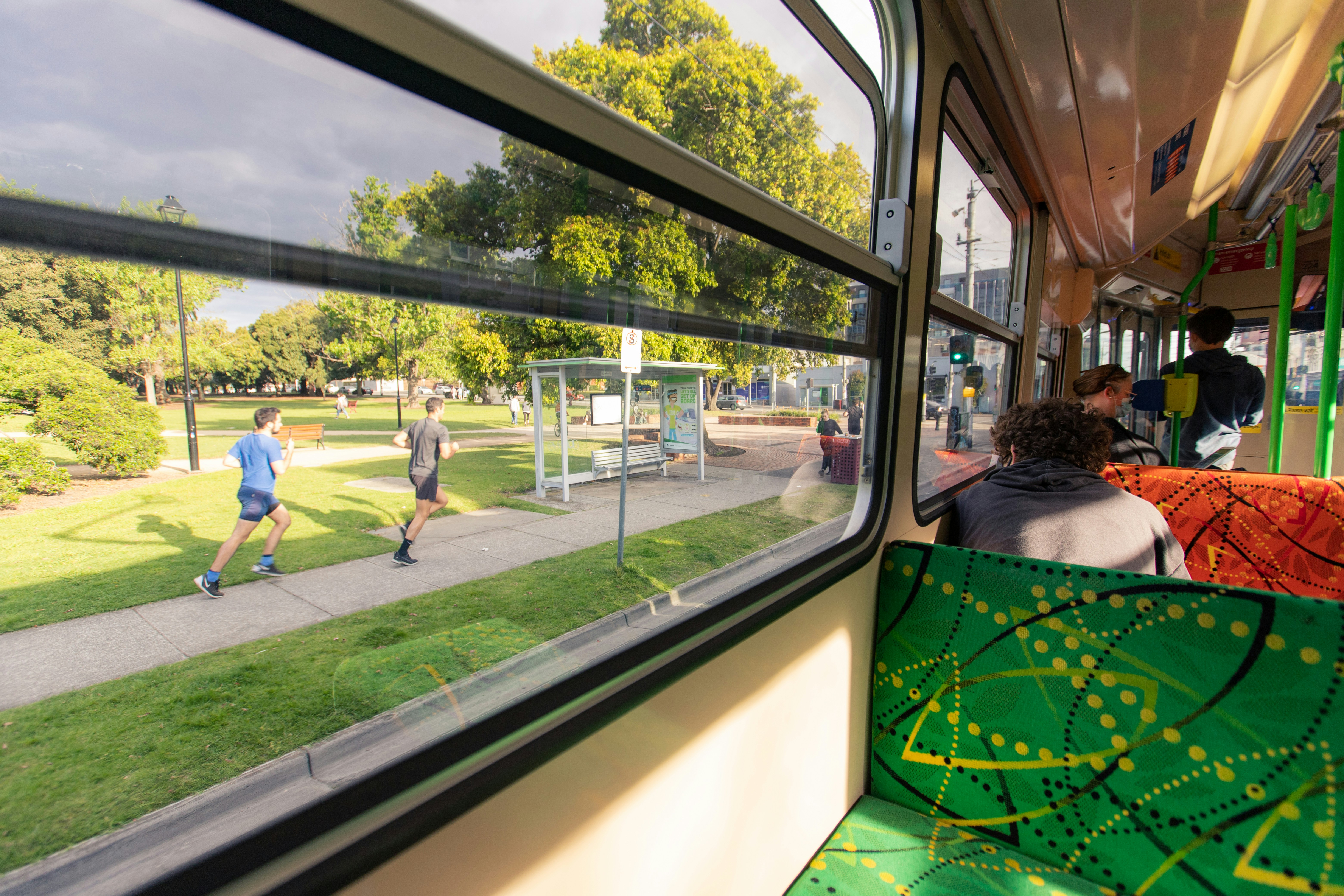 A group of people riding a bus down a street photo – Free Health Image ...