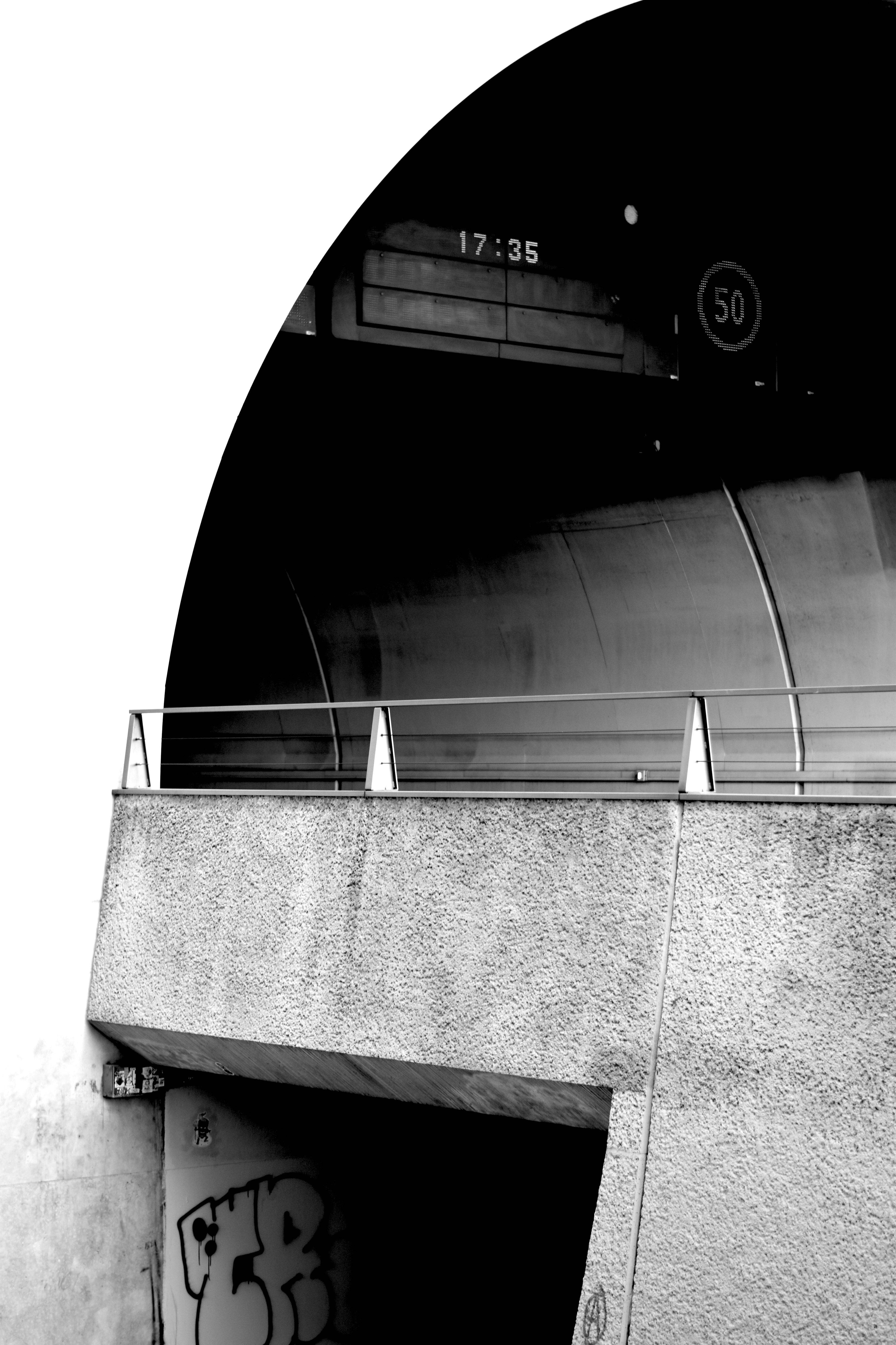 Monochrome Underpass: A Concrete Balcony Framing a Circular Void