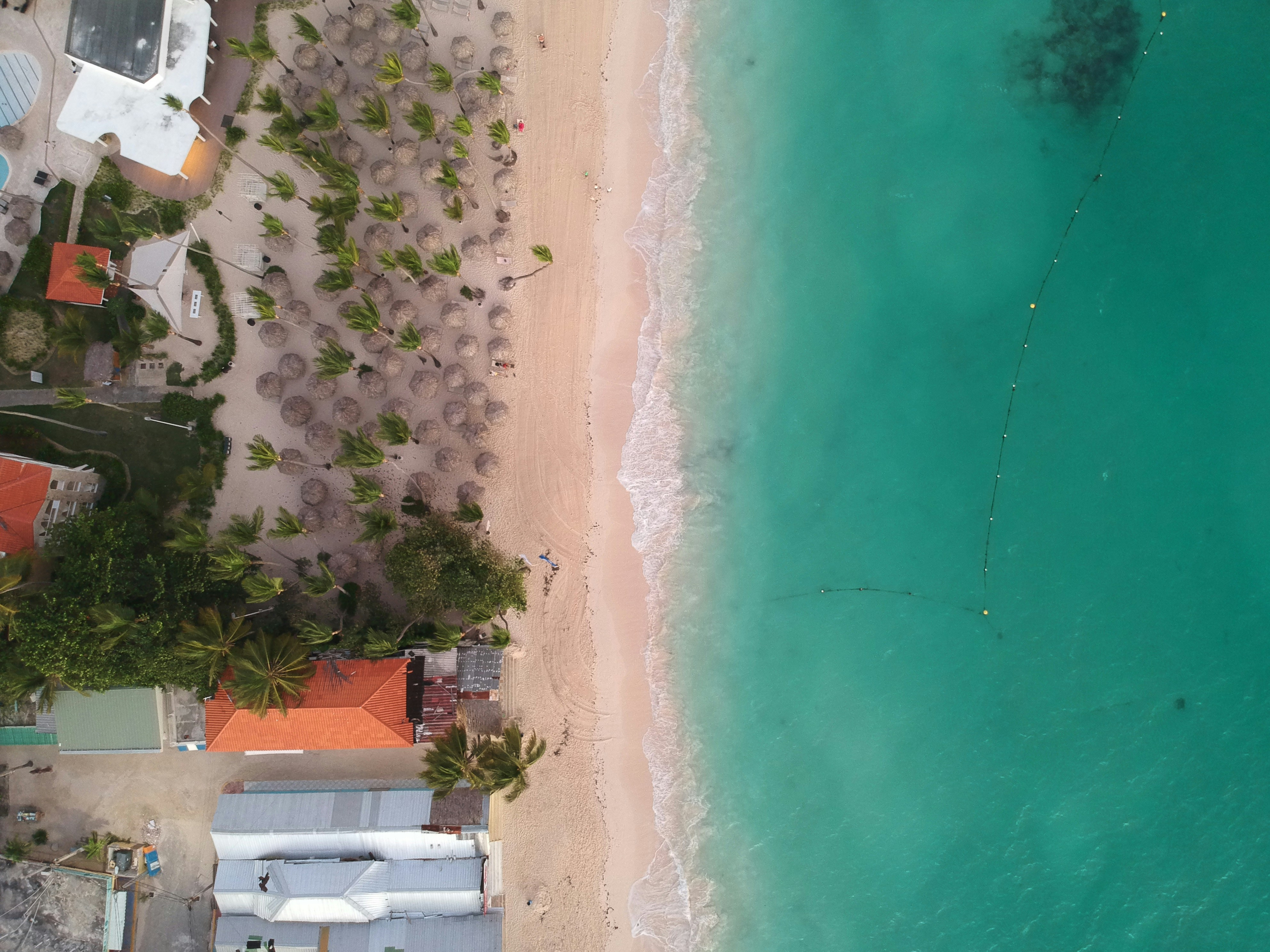 Foto Una vista aérea de una playa con un barco en el agua – Imagen ...