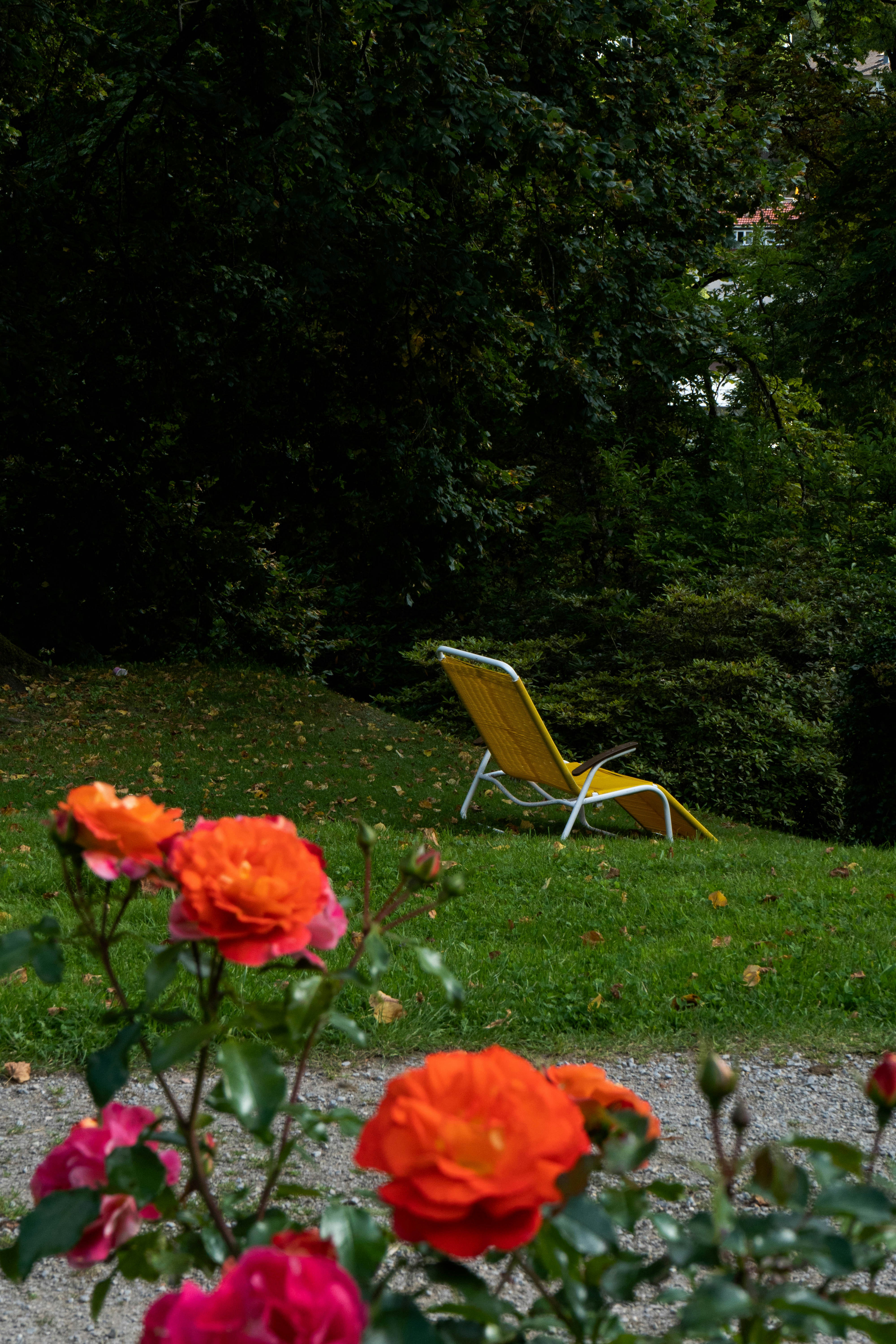 a yellow lawn chair sitting on top of a lush green field