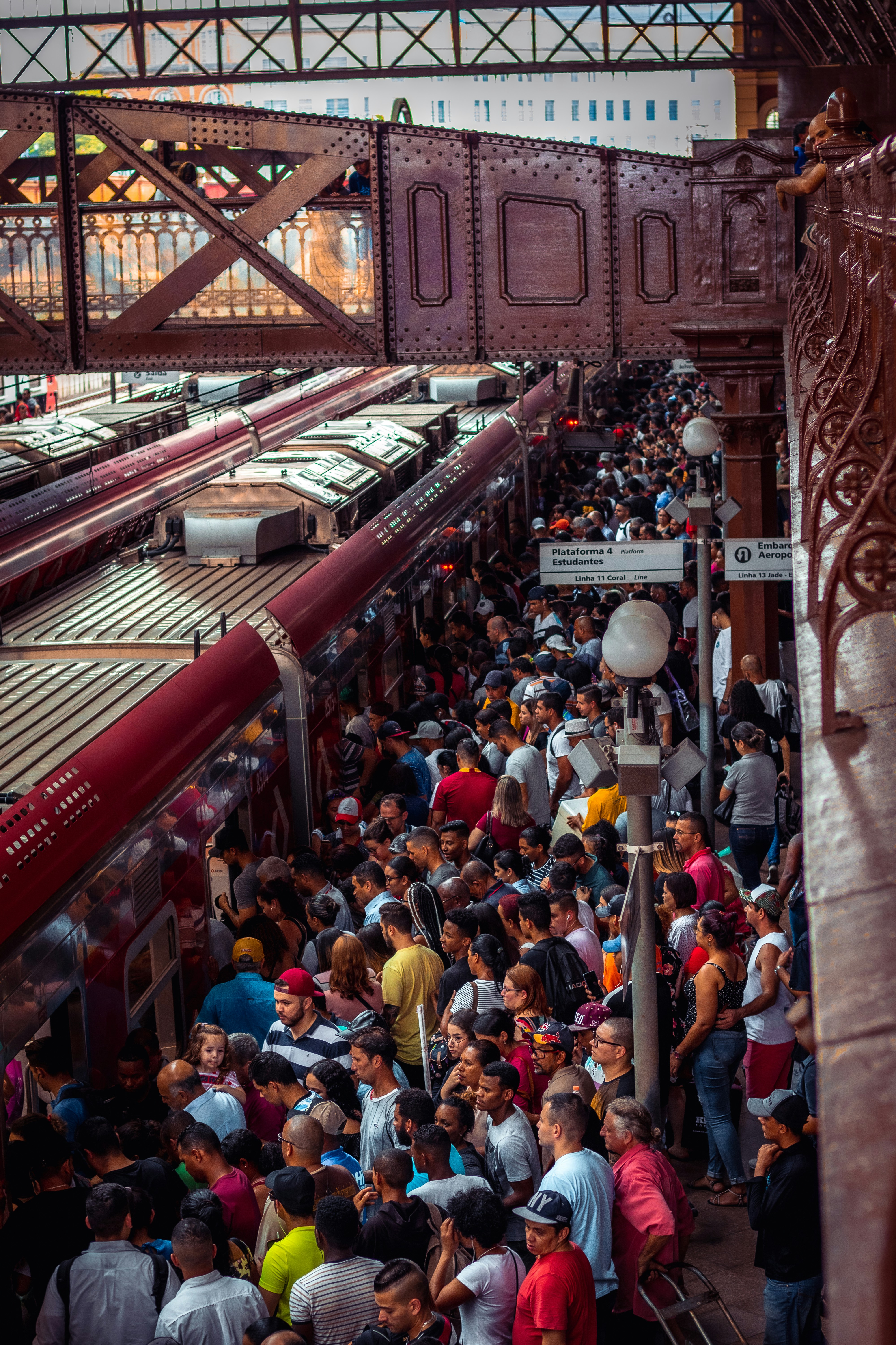 Rush of Rails: Crowded Platform Beneath Ironwork