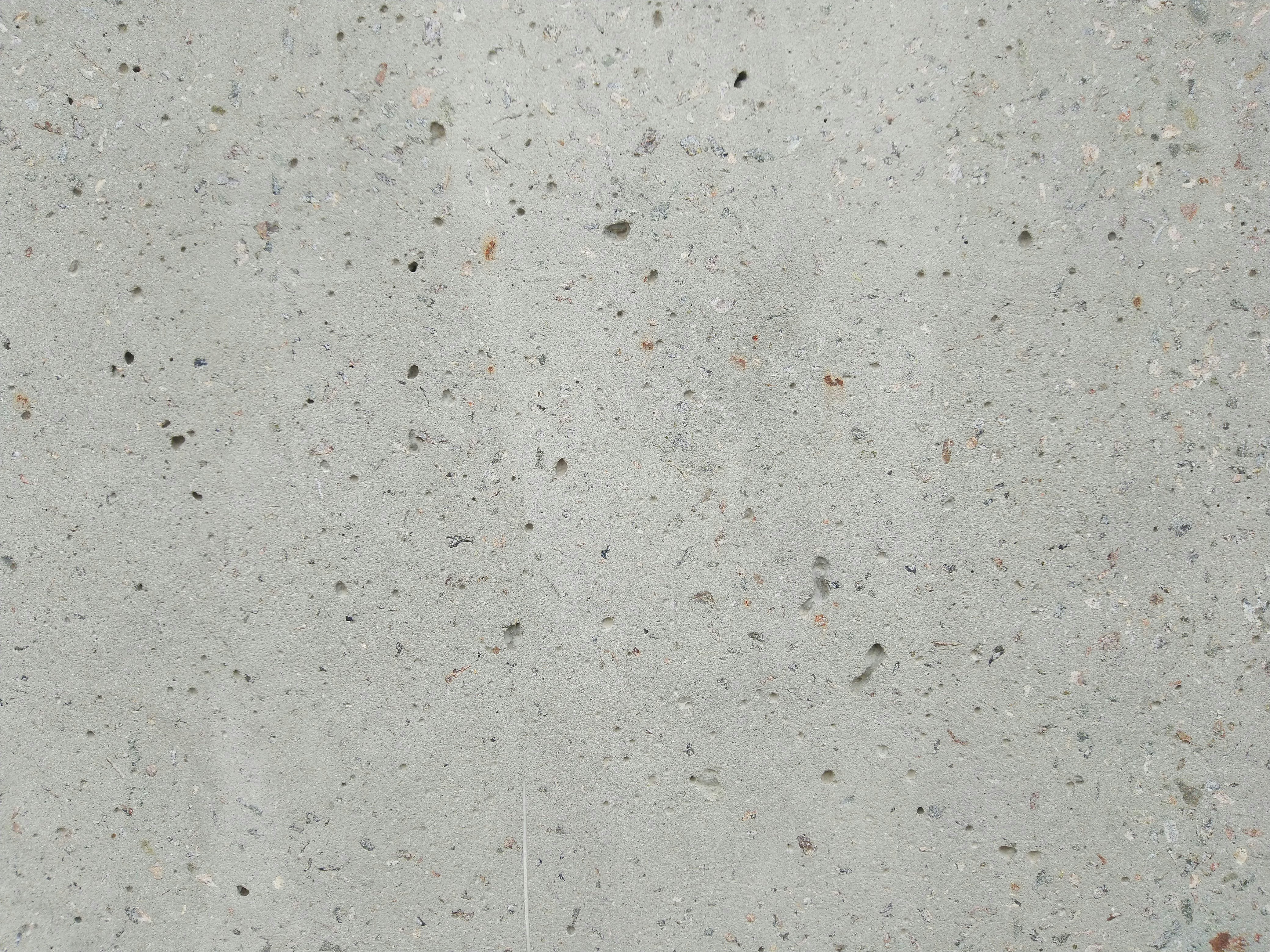 Close-up view of a concrete surface showcasing its unique texture and mineral inclusions.