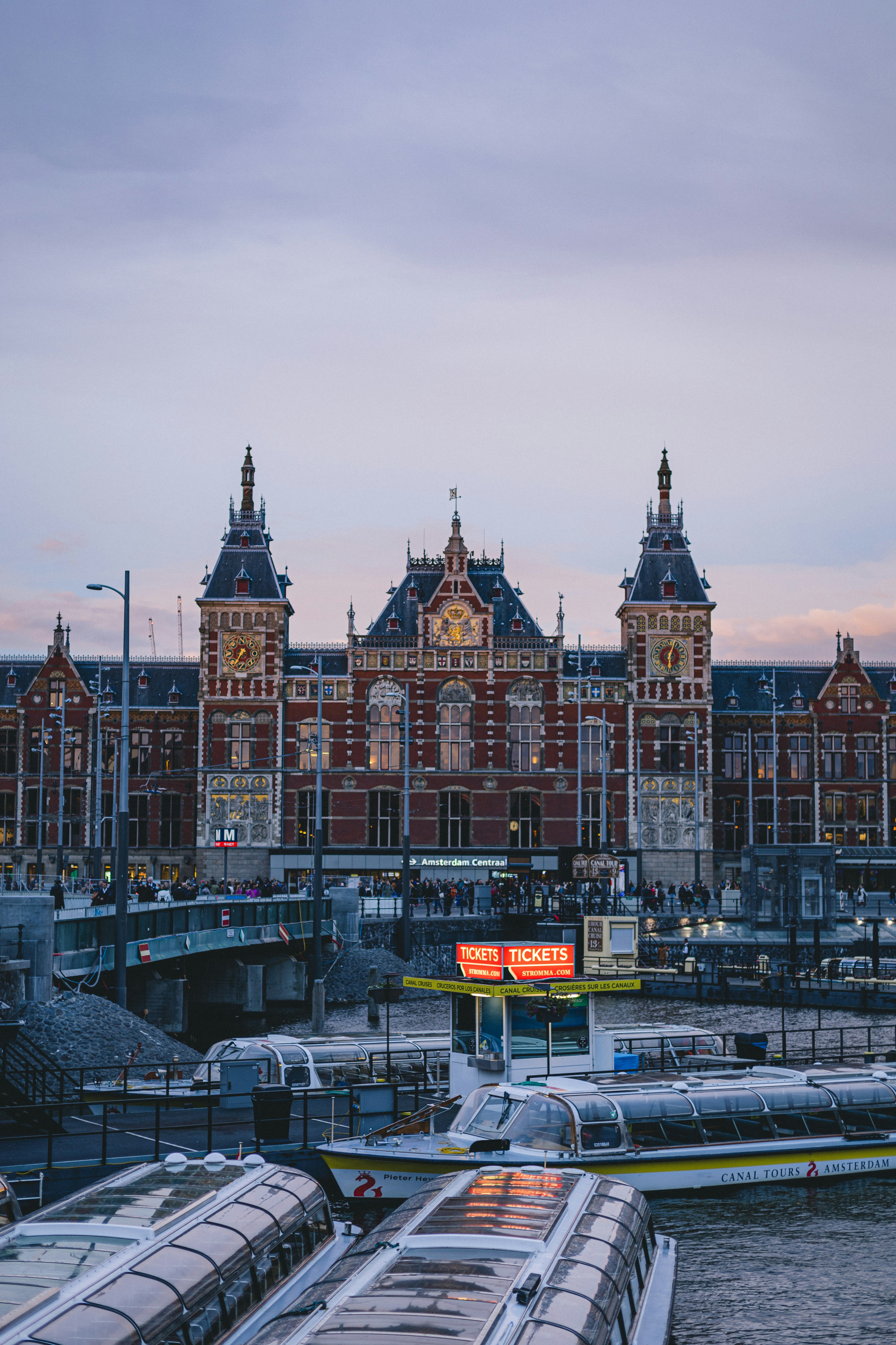 Dusk Over Amsterdam Central: Twin Spires Framing the Canal