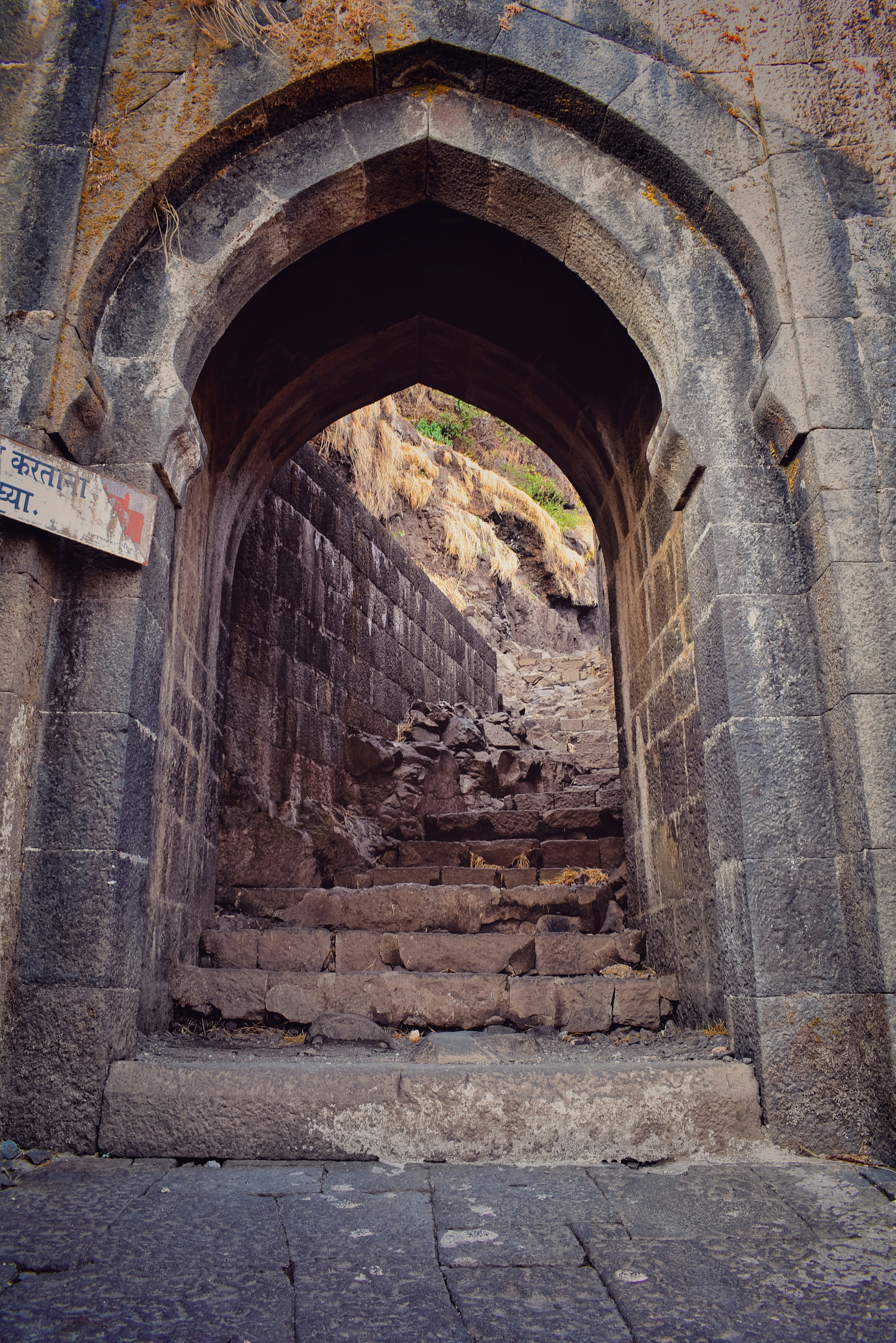 a stone tunnel with stairs leading up to it