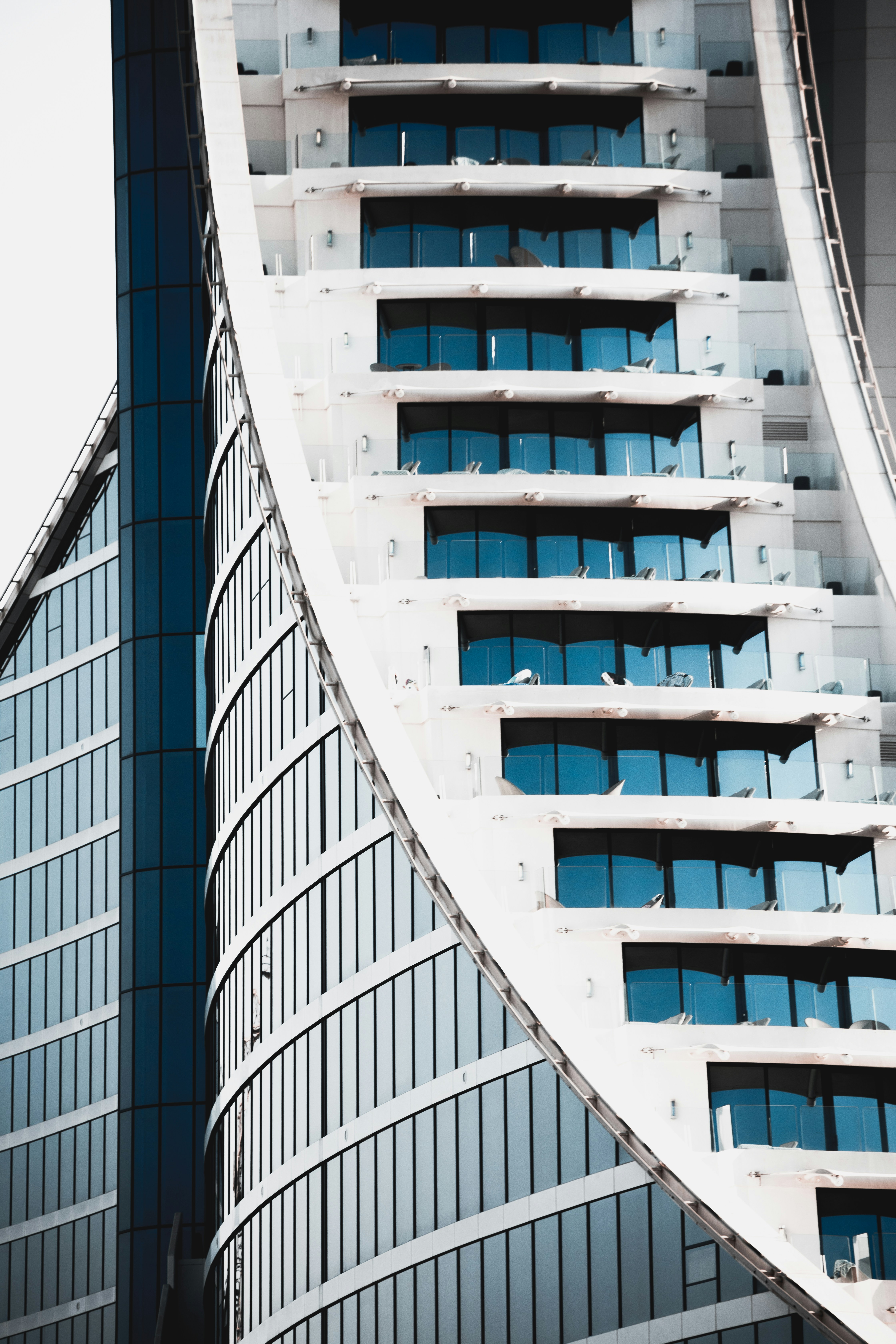 A very tall building with a spiral design on it's side photo – Free ...