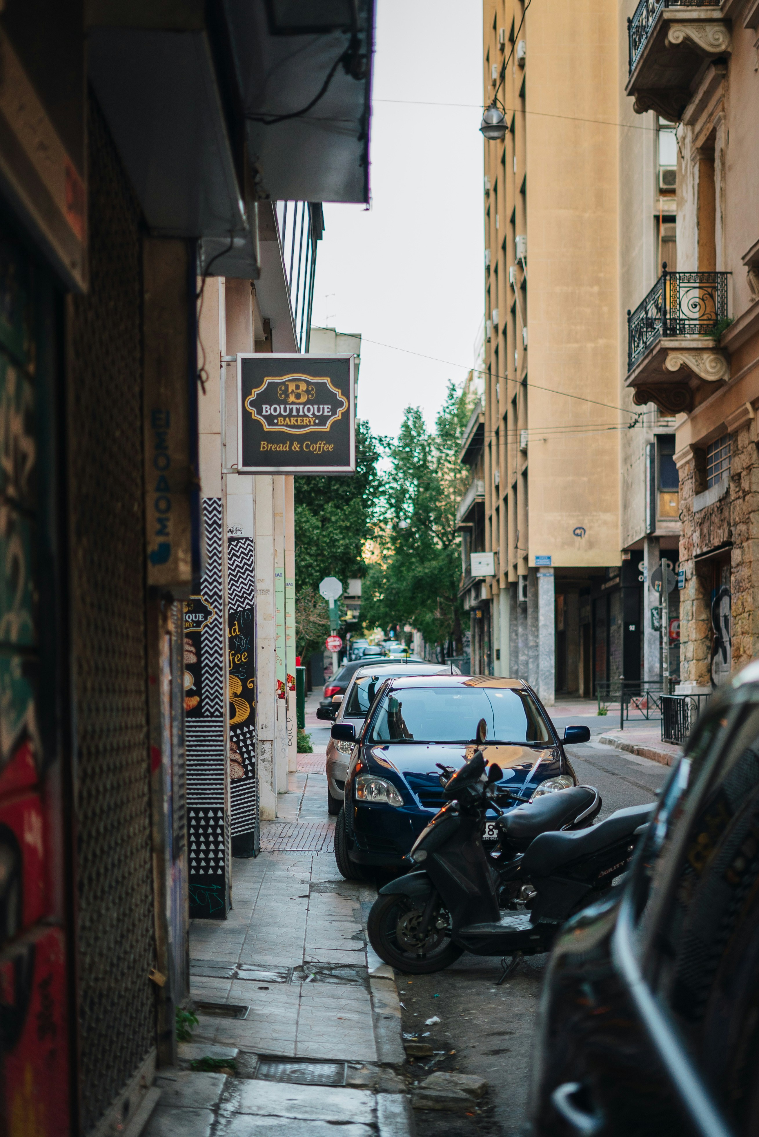 a motorcycle parked on the side of a street next to a parked car