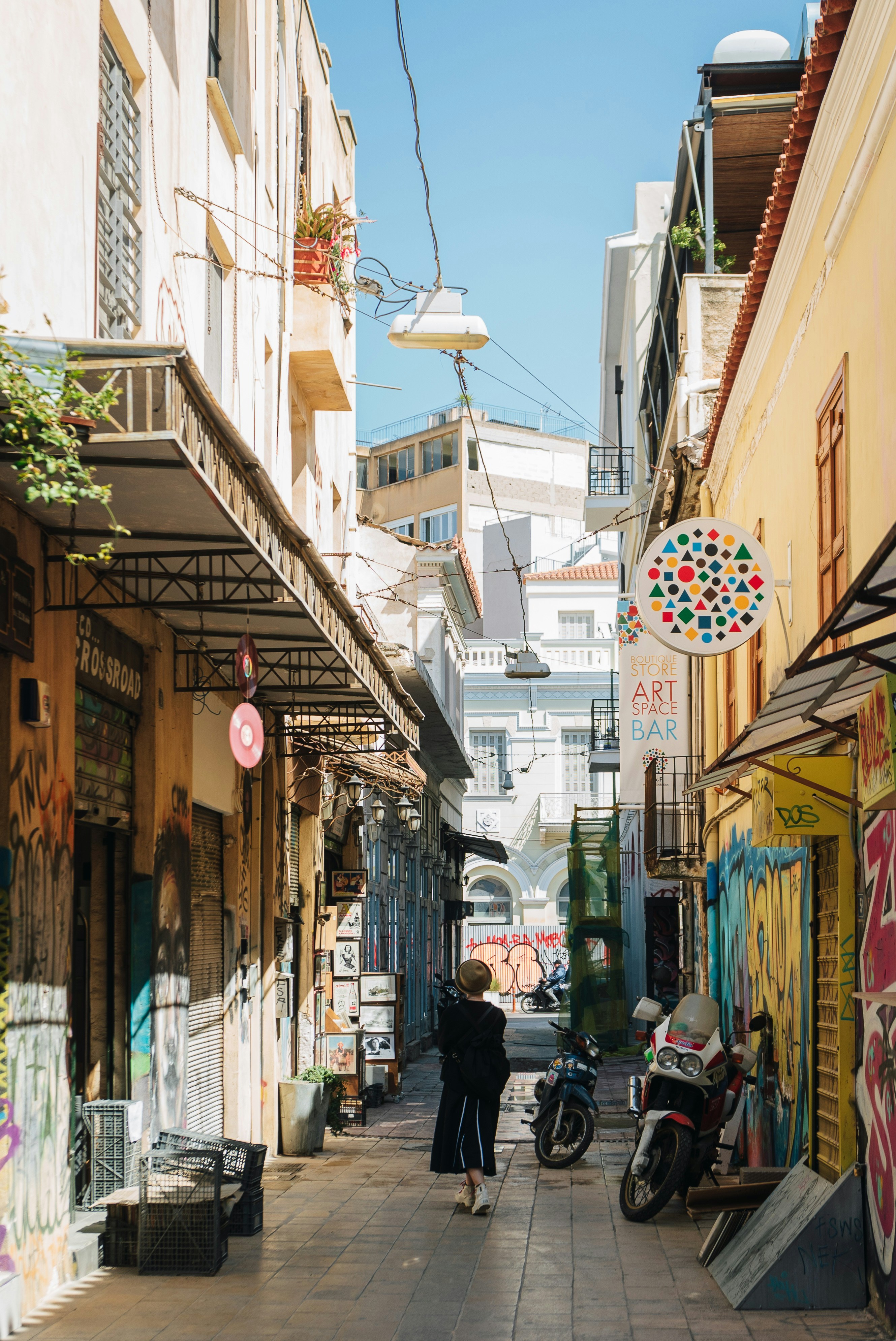 Narrow Street Studio: Sunlit alley with graffiti and scooters