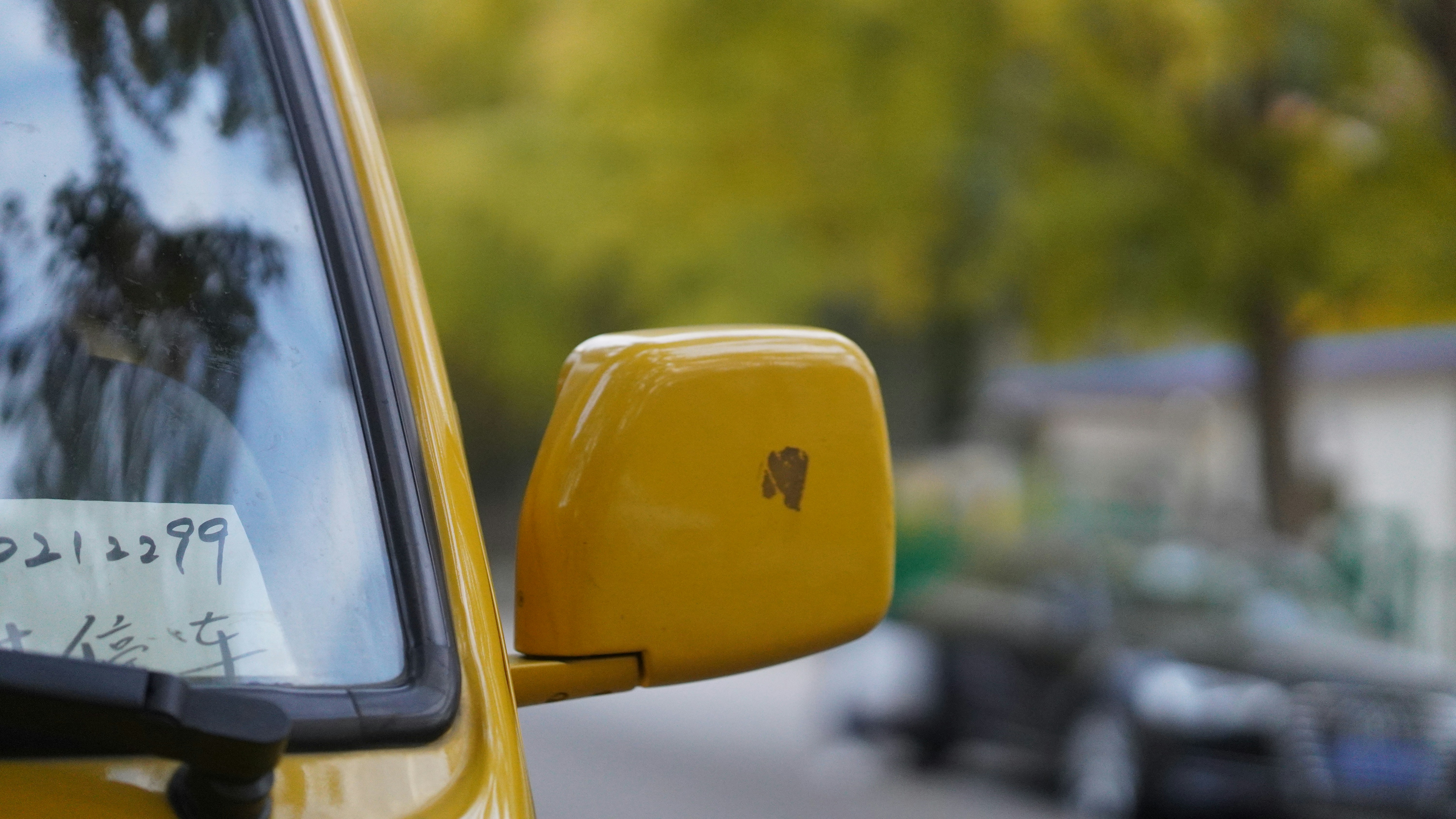Amber Taxi Mirror in a Quiet City Blur