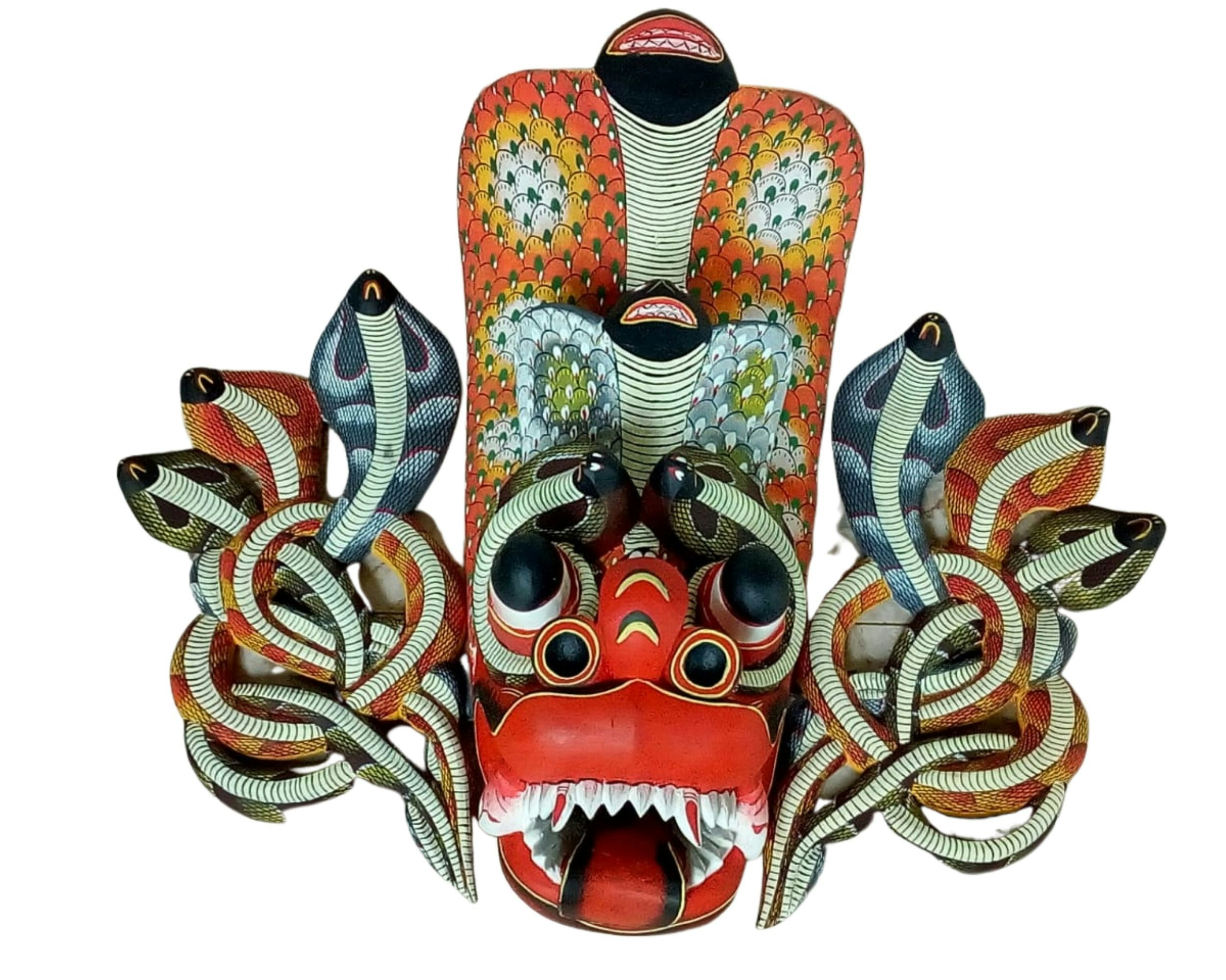 A red mask with two snakes on it's face photo – Free Mask Image on Unsplash