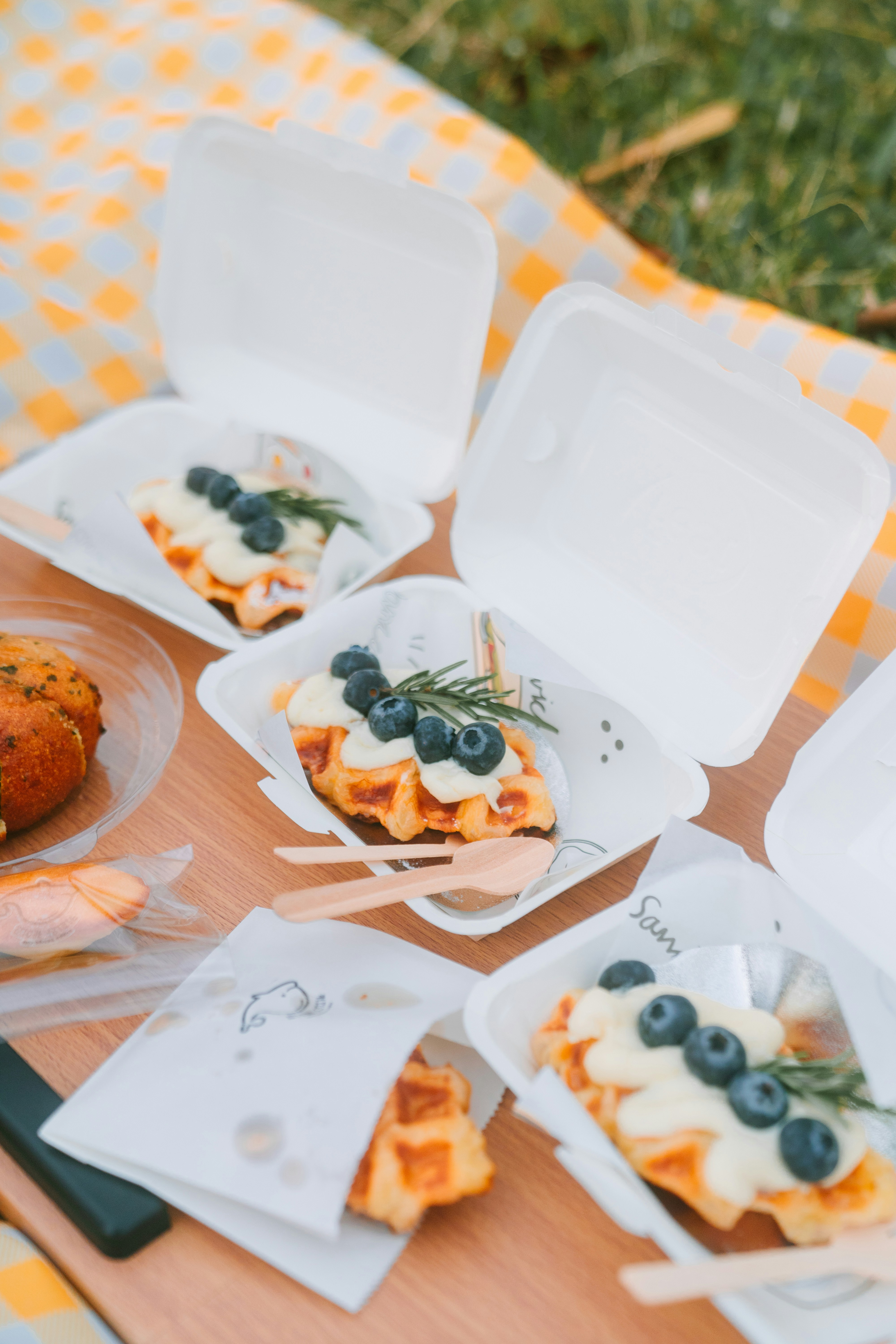 Blueberry-Topped Waffle Stacks on a Sunlit Picnic Spread