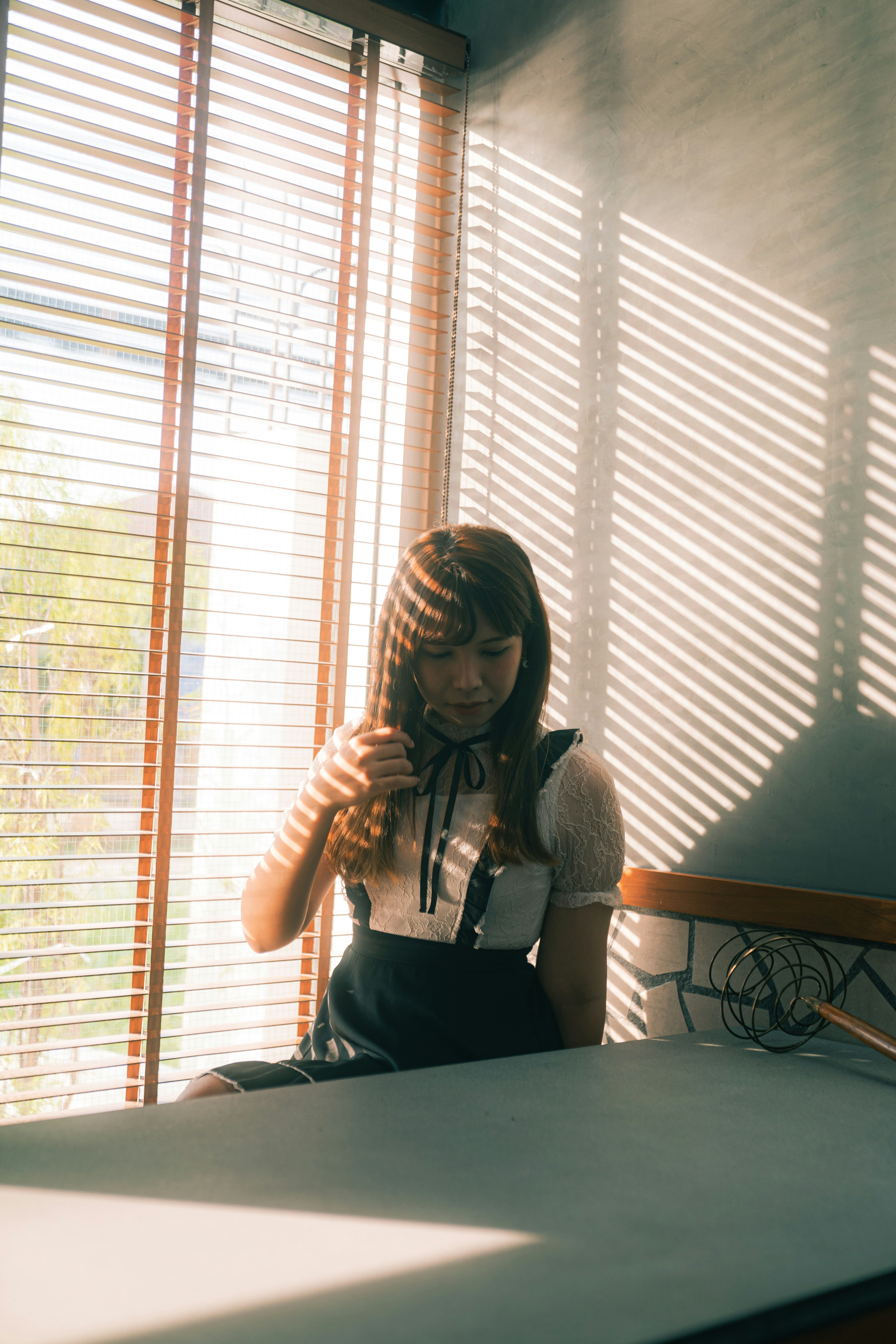 Quiet Moment in Striped Sunlight: A Window-Side Portrait