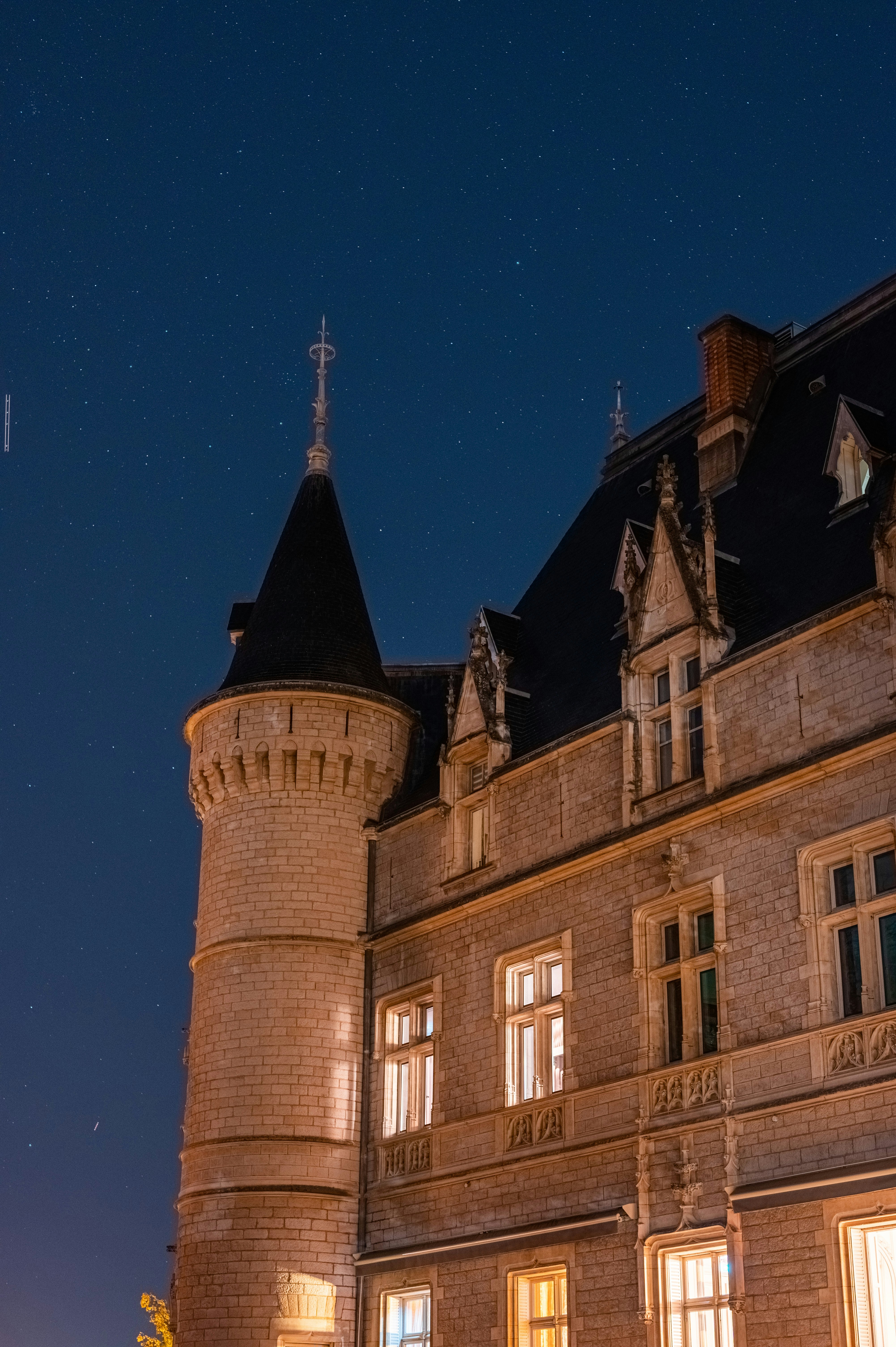 Starfield Over a Turreted Castle: Warm Light on Stone