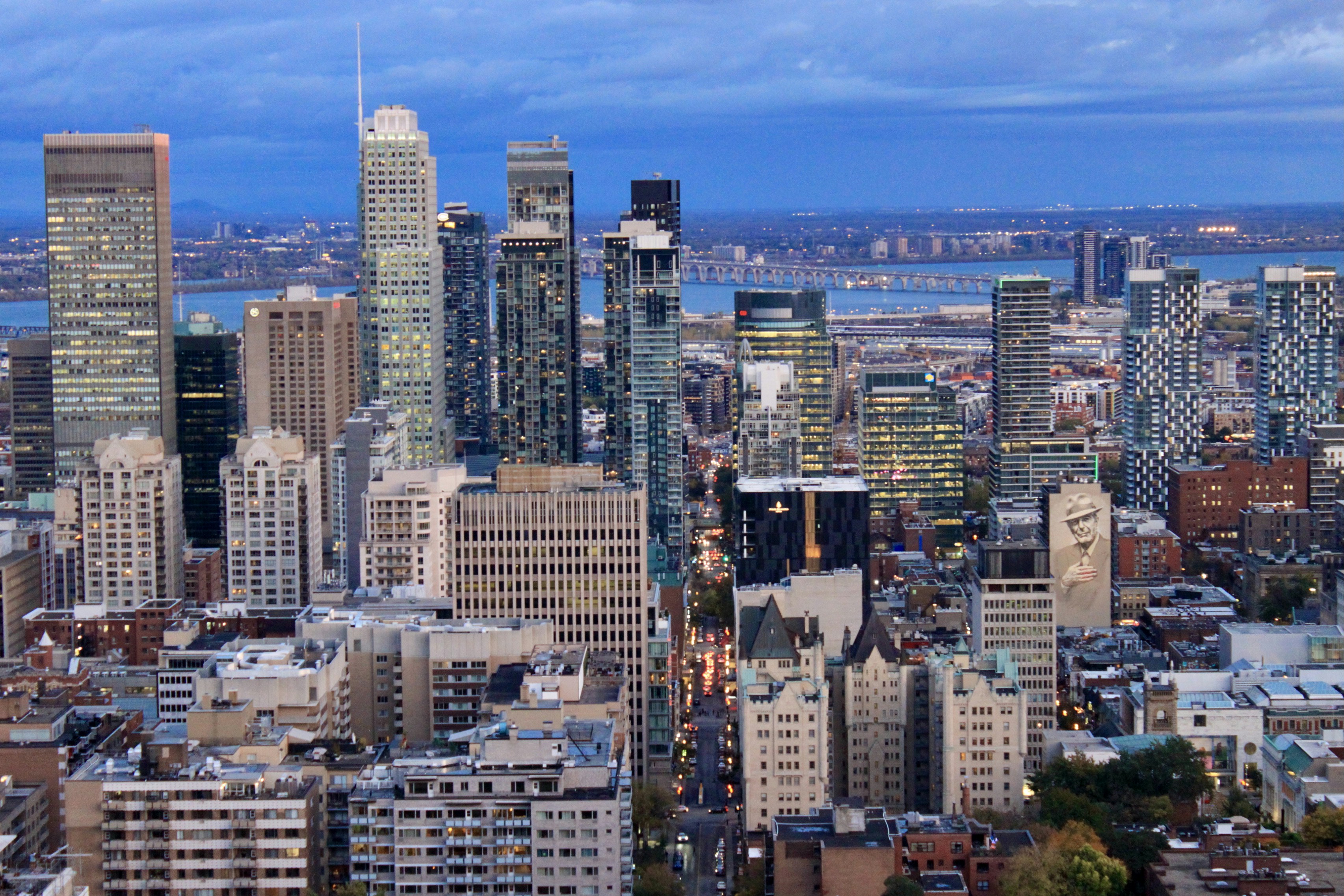 City skyline with diverse skyscrapers under a twilight sky.