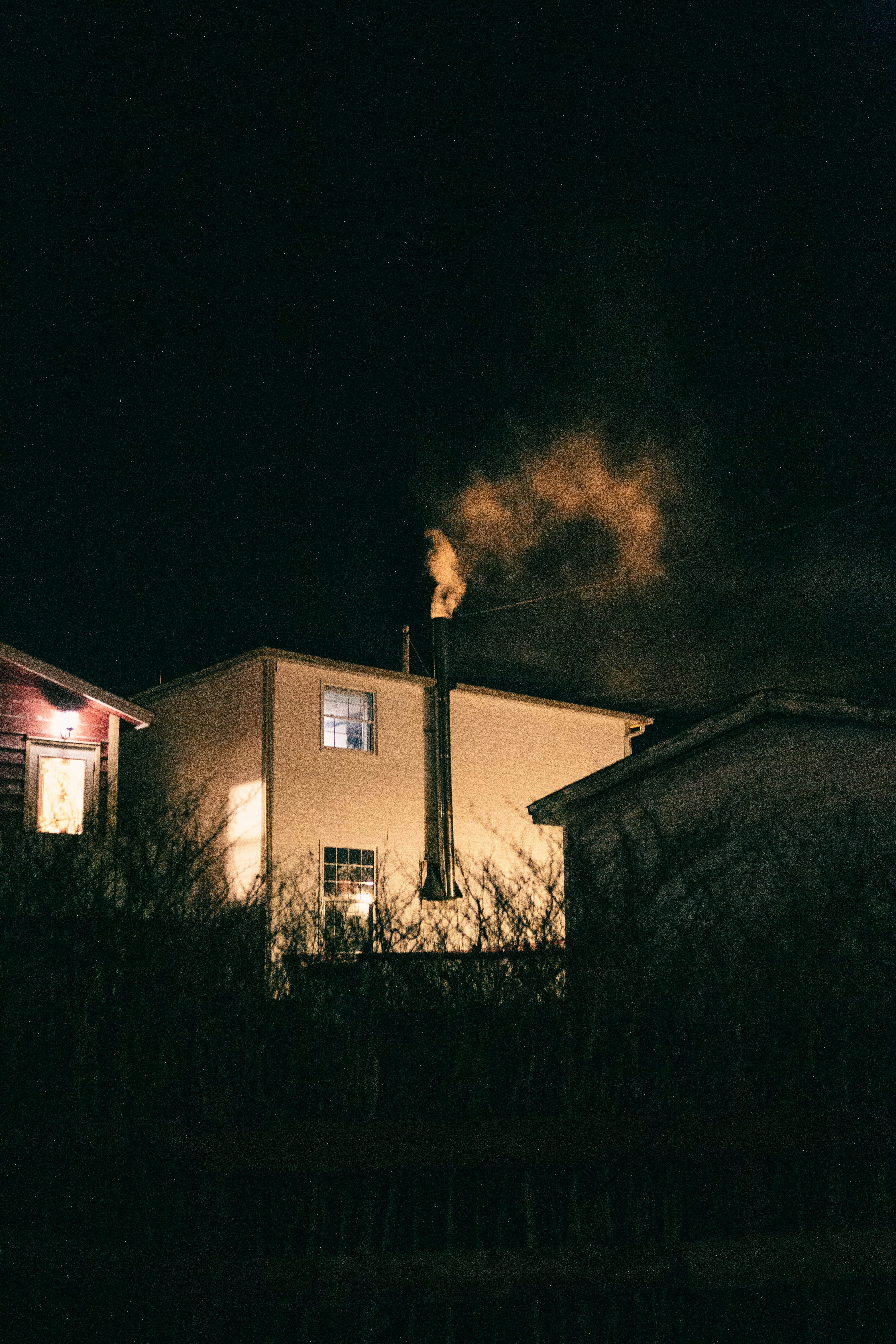 A house with smoke coming out of it at night photo – Free Building ...