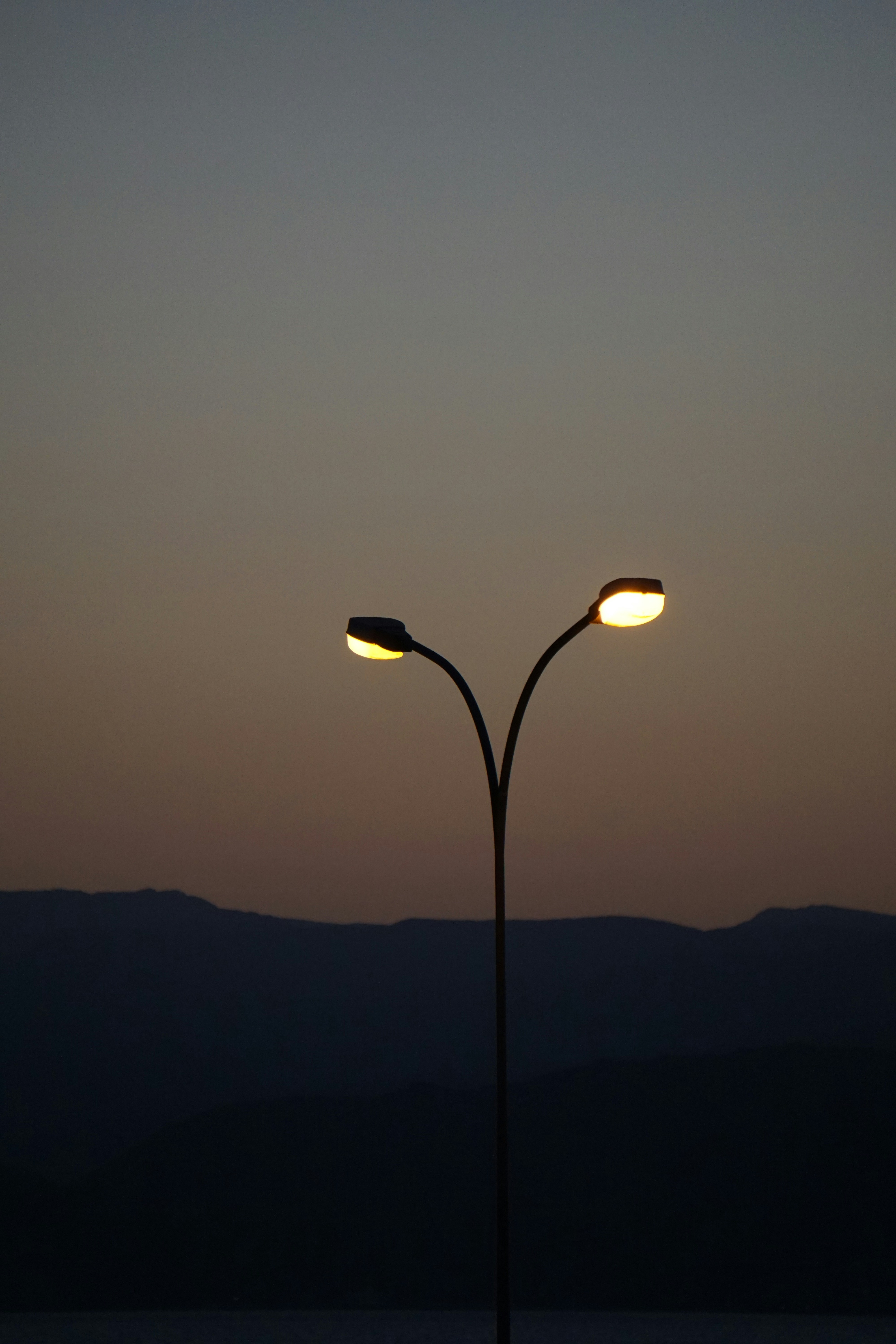 a street light with a sunset in the background
