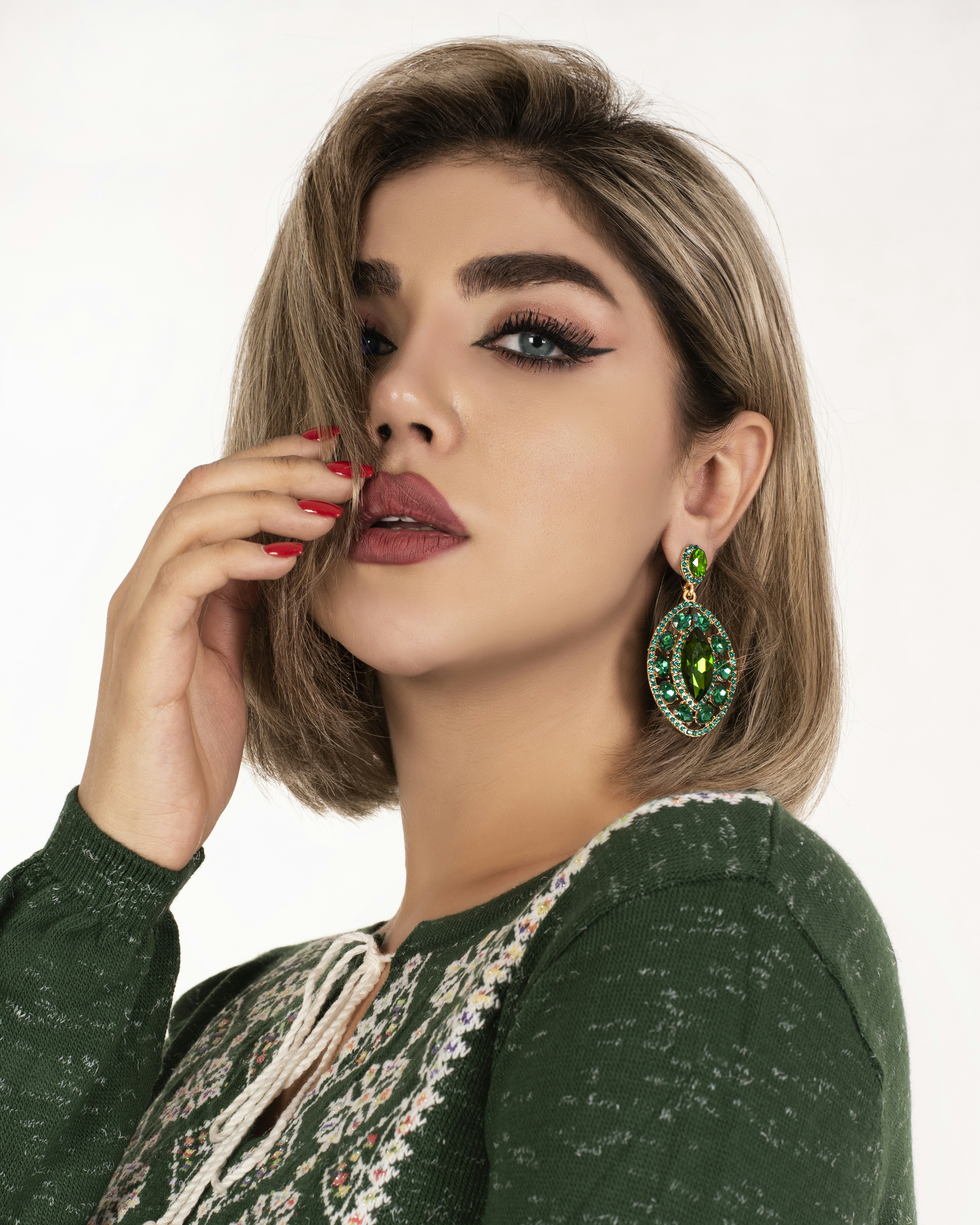 Emerald Gaze in Studio Light: A Portrait of Poised Glamour