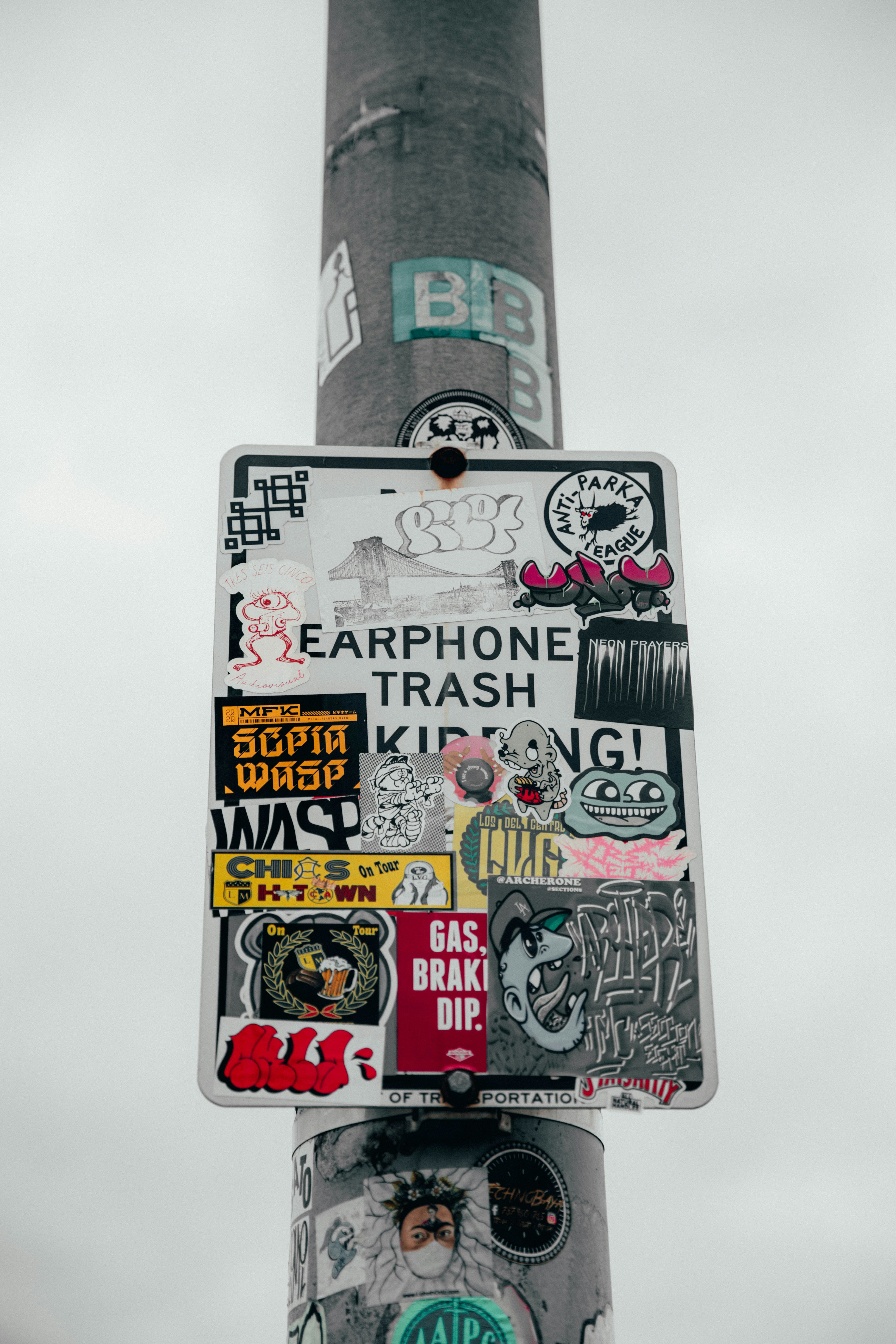 A pole with a bunch of stickers on it photo – Free Label Image on Unsplash