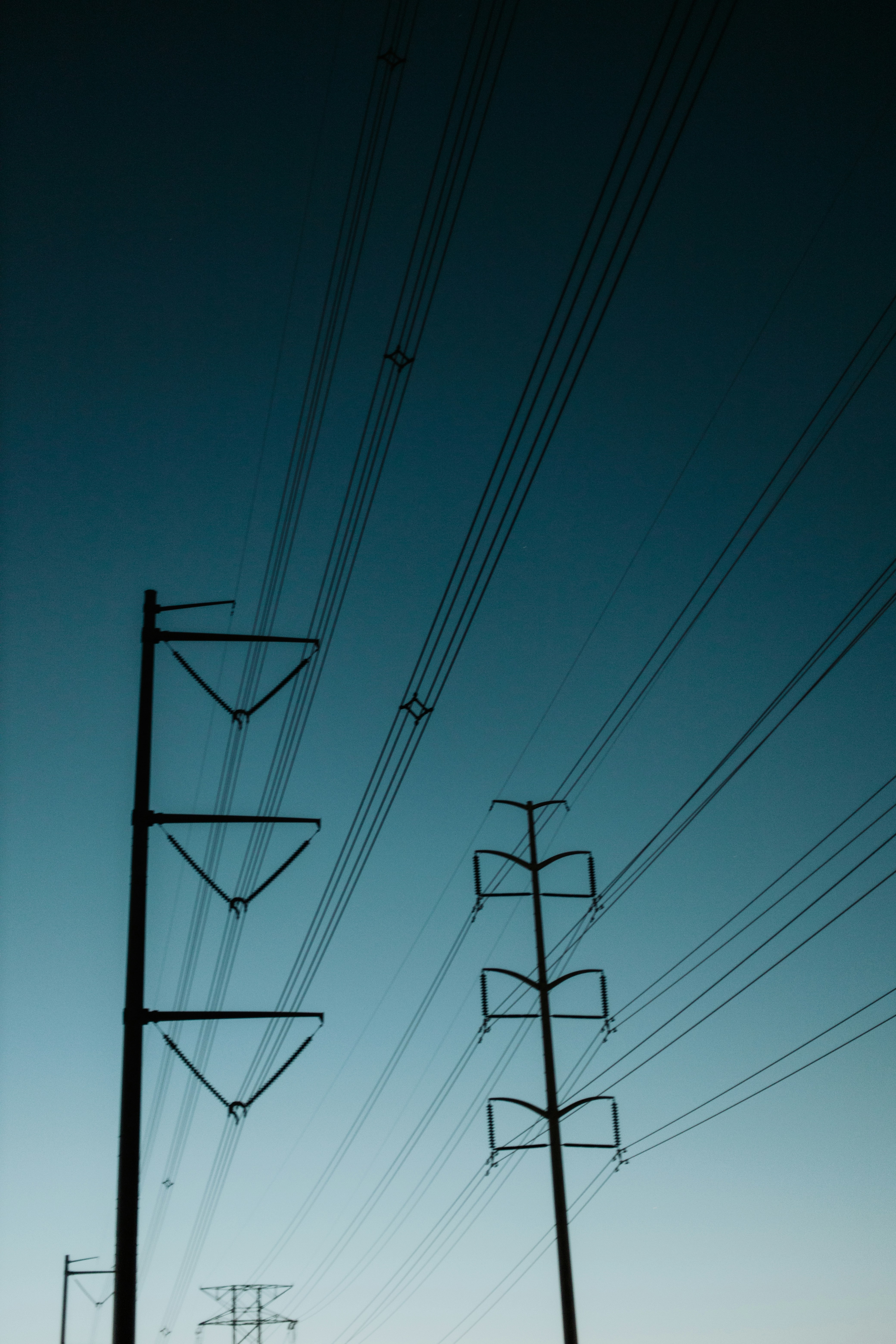 A car driving down a road next to power lines photo – Free Grey Image ...