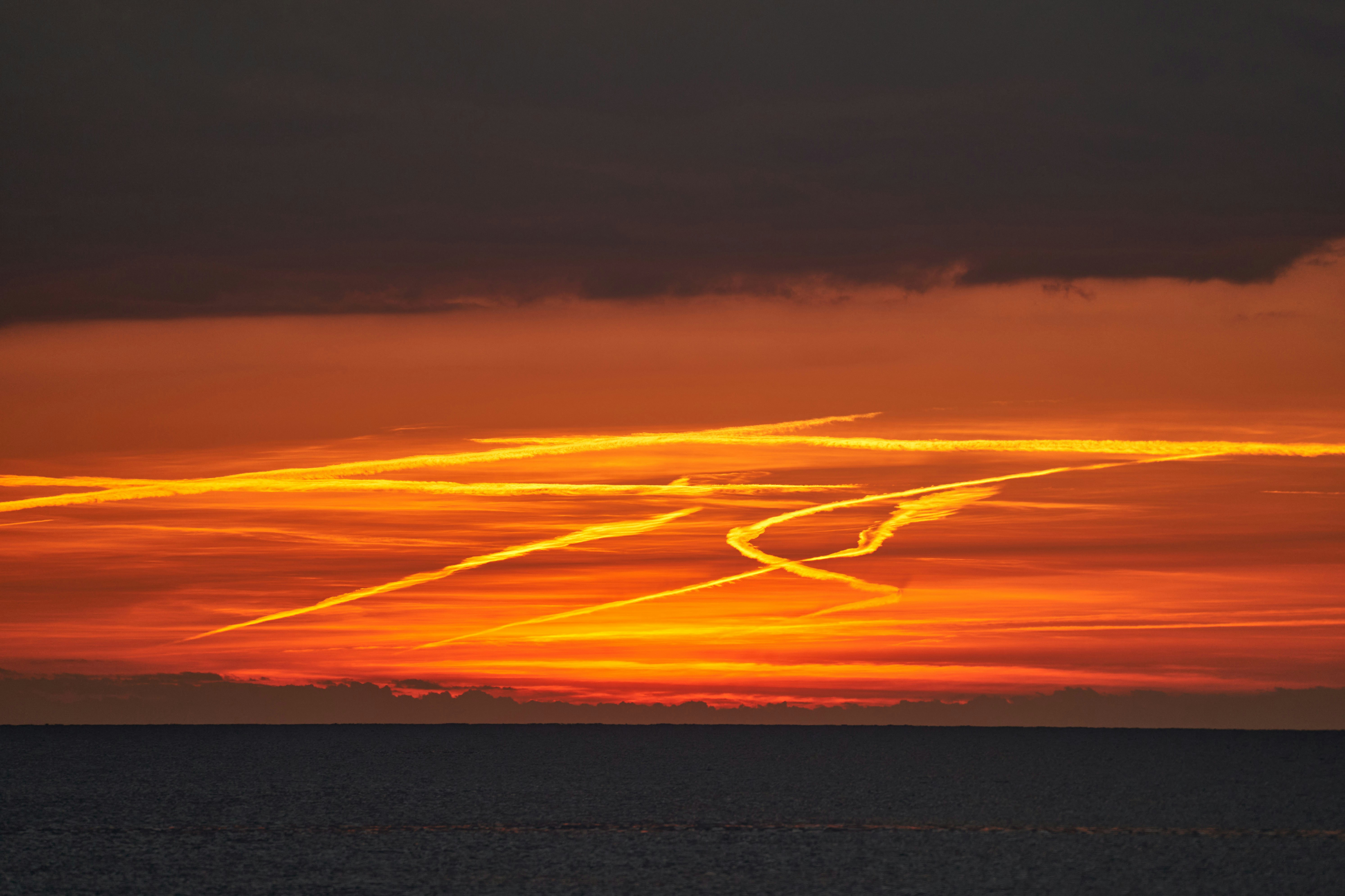 Crimson Horizon: Veins of Light Across a Quiet Sea