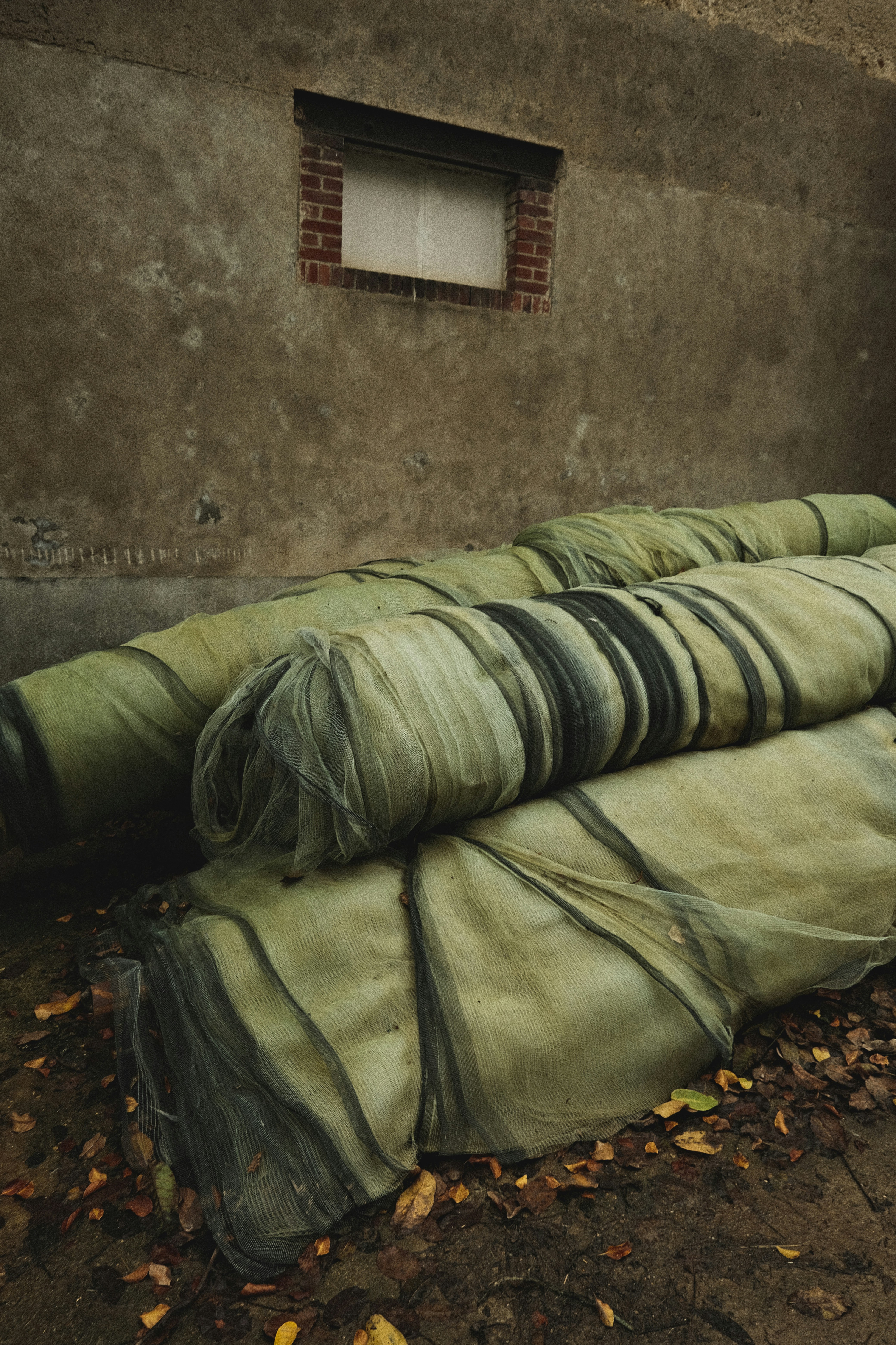 A pile of green tarps sitting next to a building photo – Free France ...