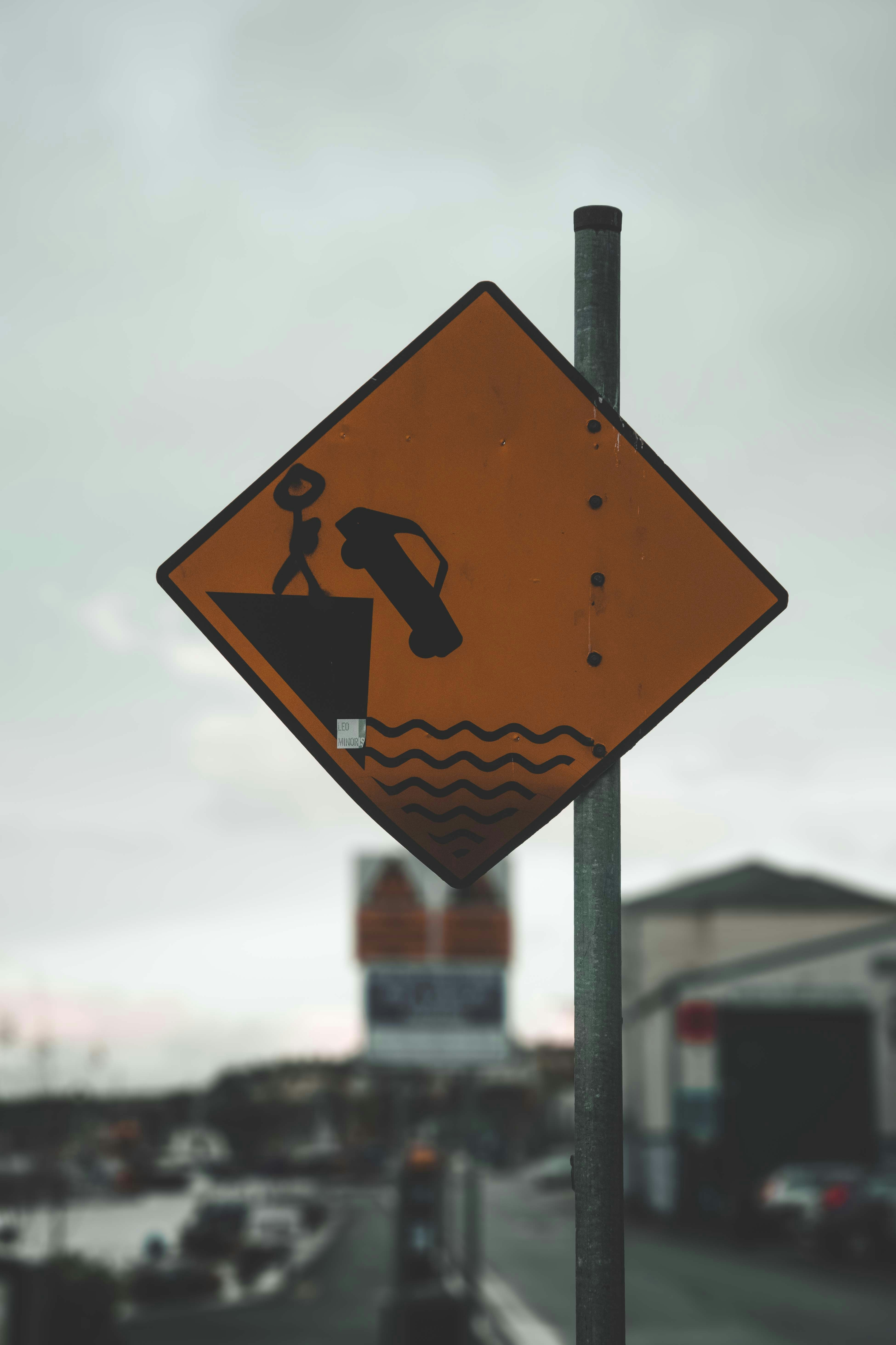 a street sign with a picture of a man holding an umbrella
