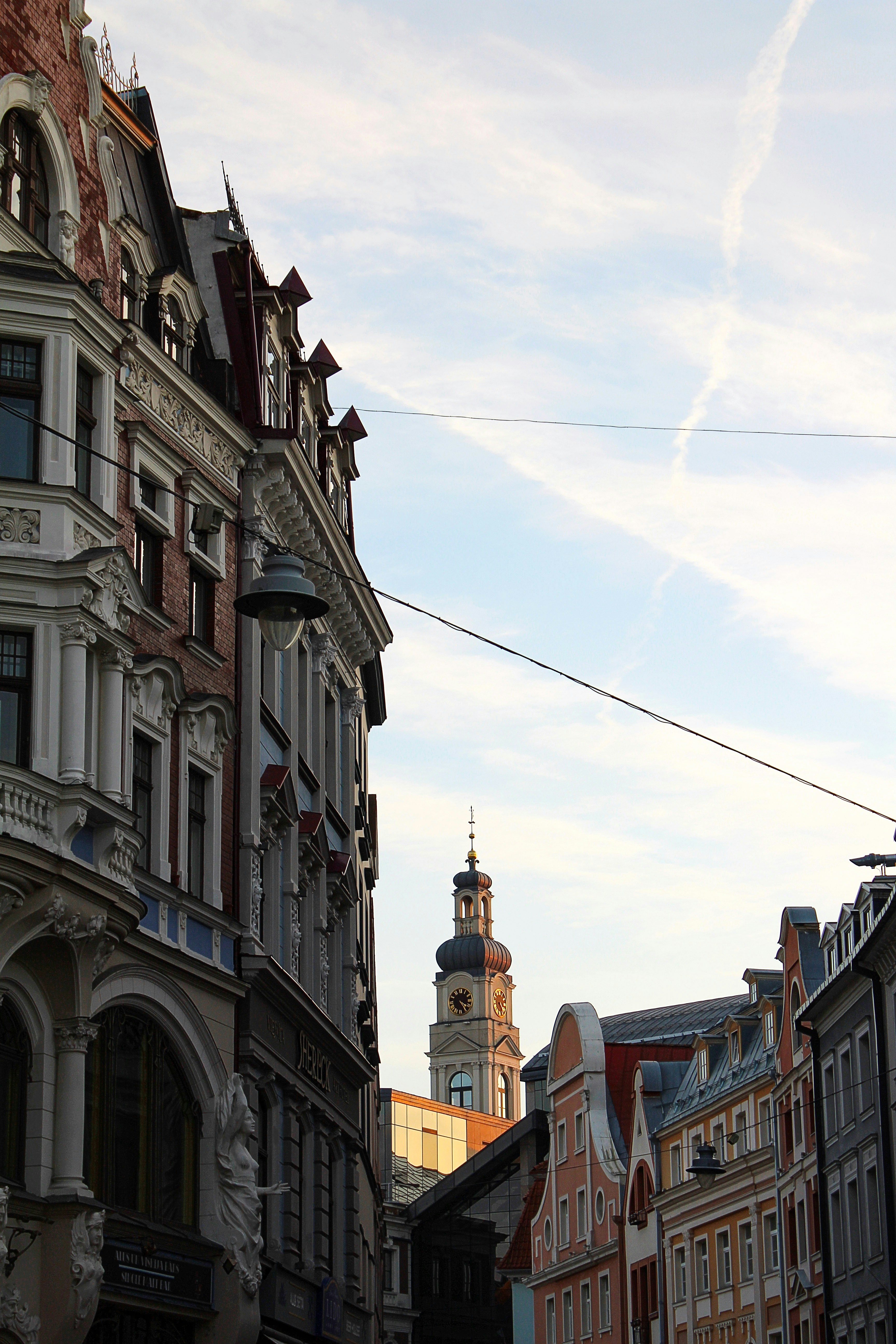 A city street with buildings and a clock tower in the background photo ...