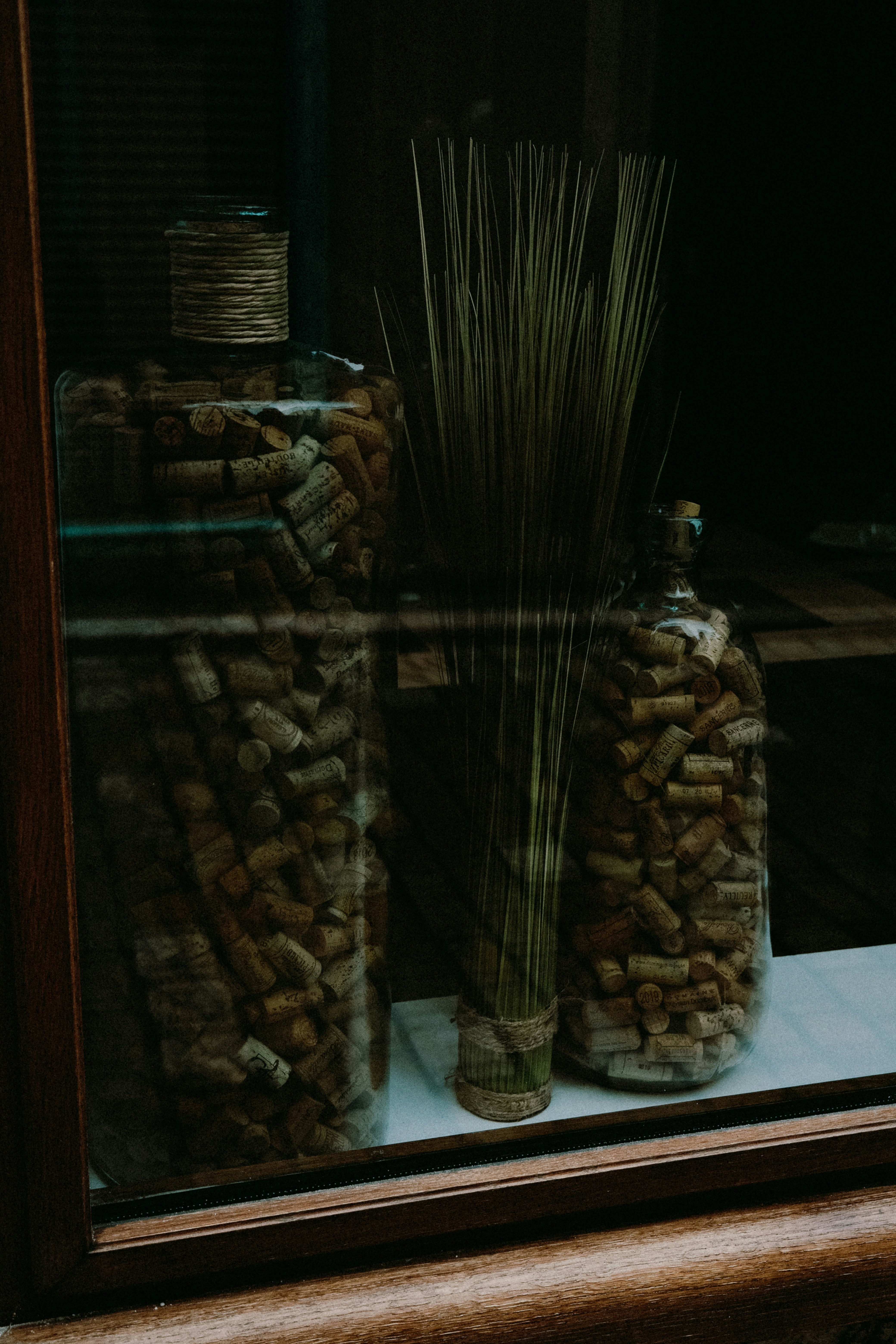 a couple of jars filled with grass next to each other