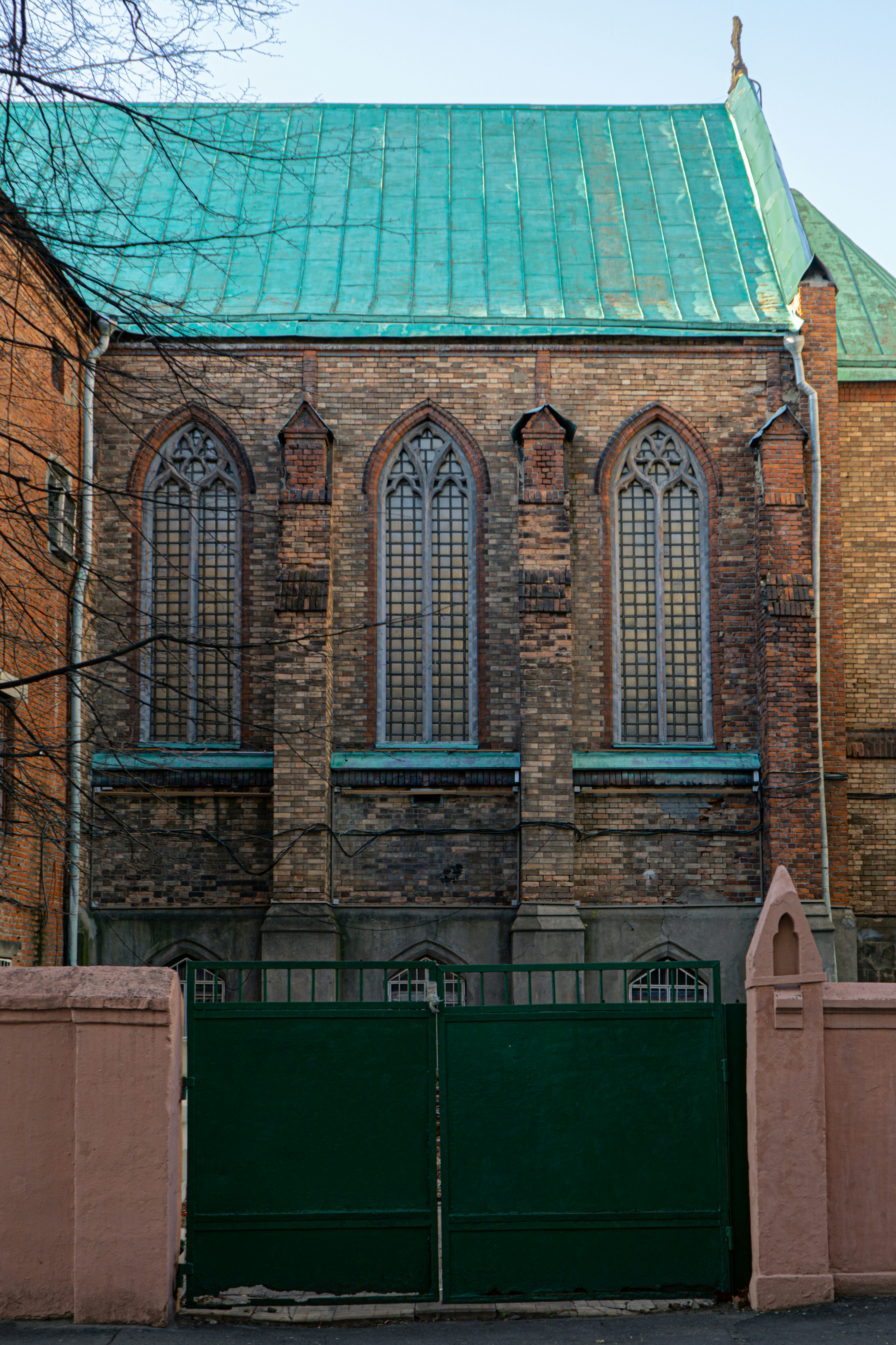 a large brick building with a green roof