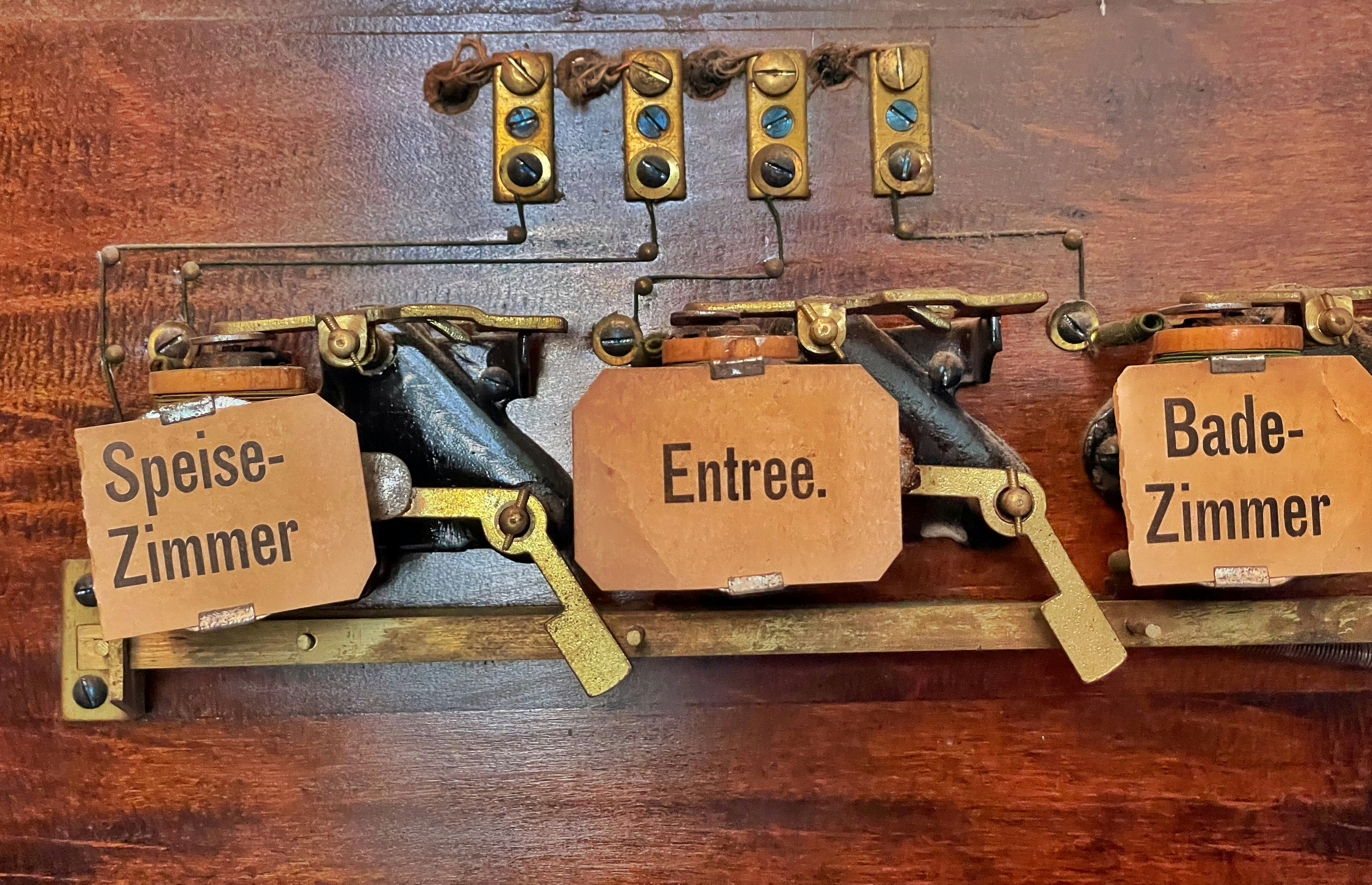 a couple of old typewriters sitting on top of a wooden table