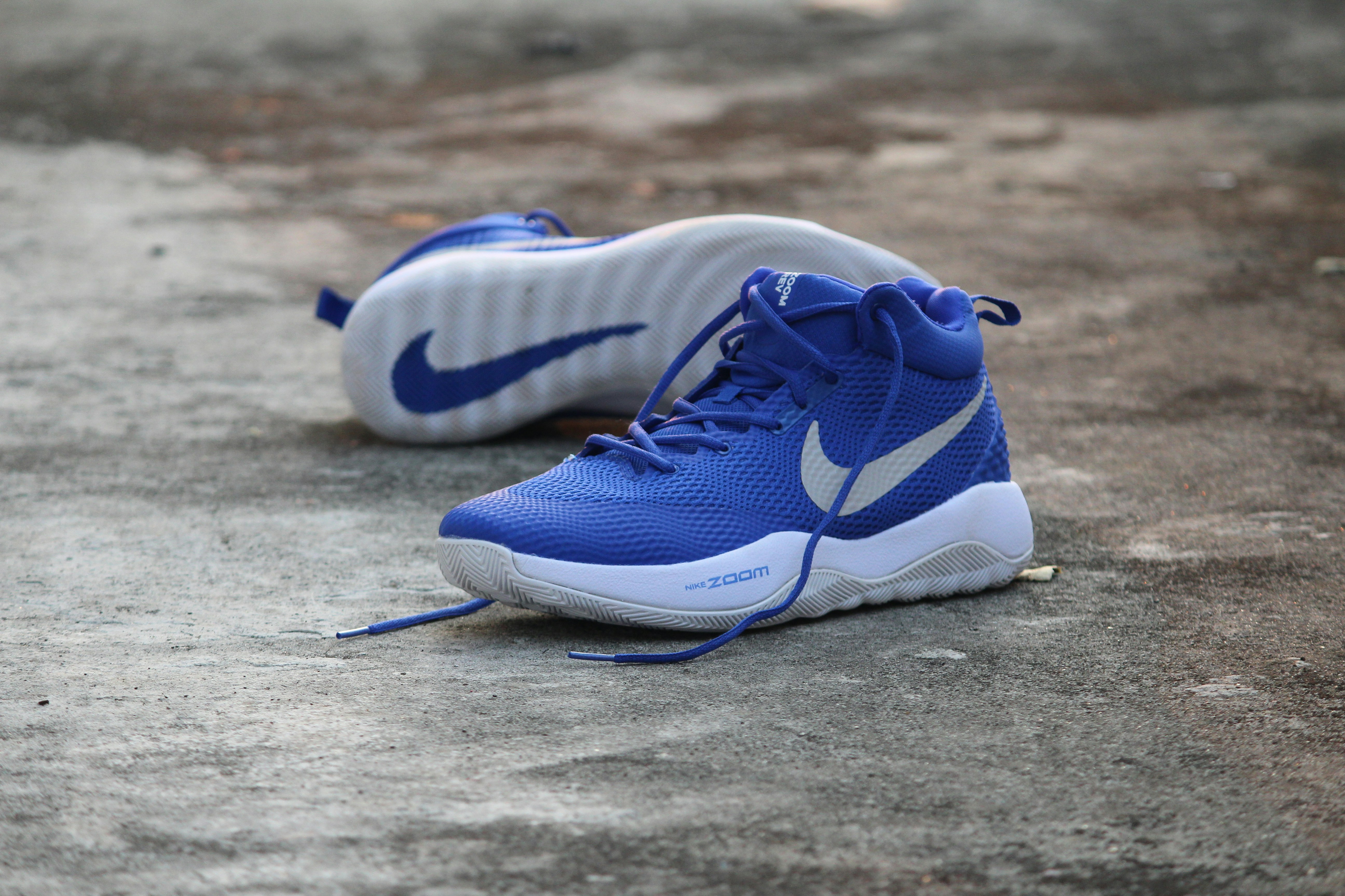 A pair of blue and white shoes on the ground photo – Free Shoes Image ...