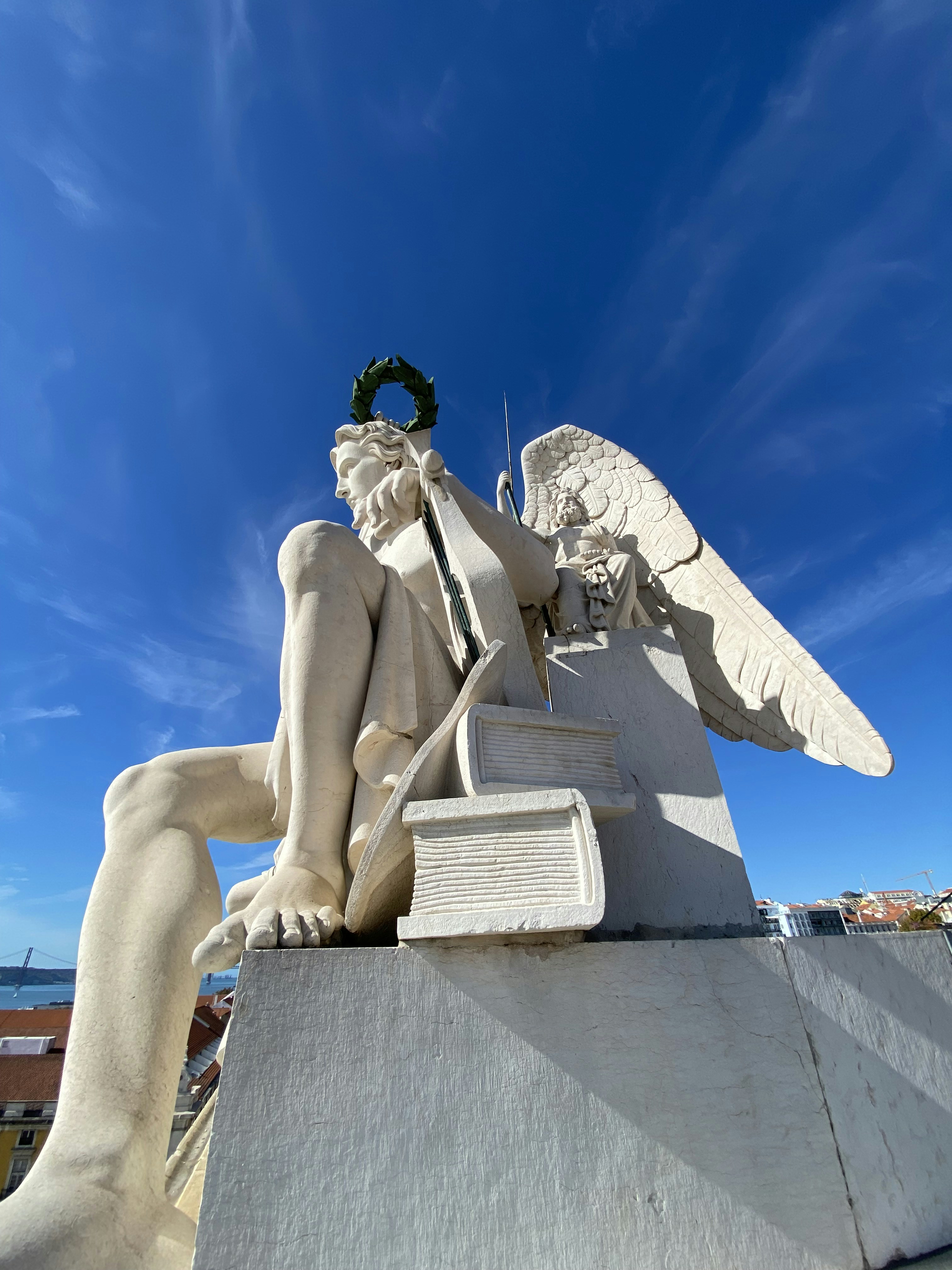 Laurel-Wreathed Sentinel: Marble Angel Overlooking the Harbor