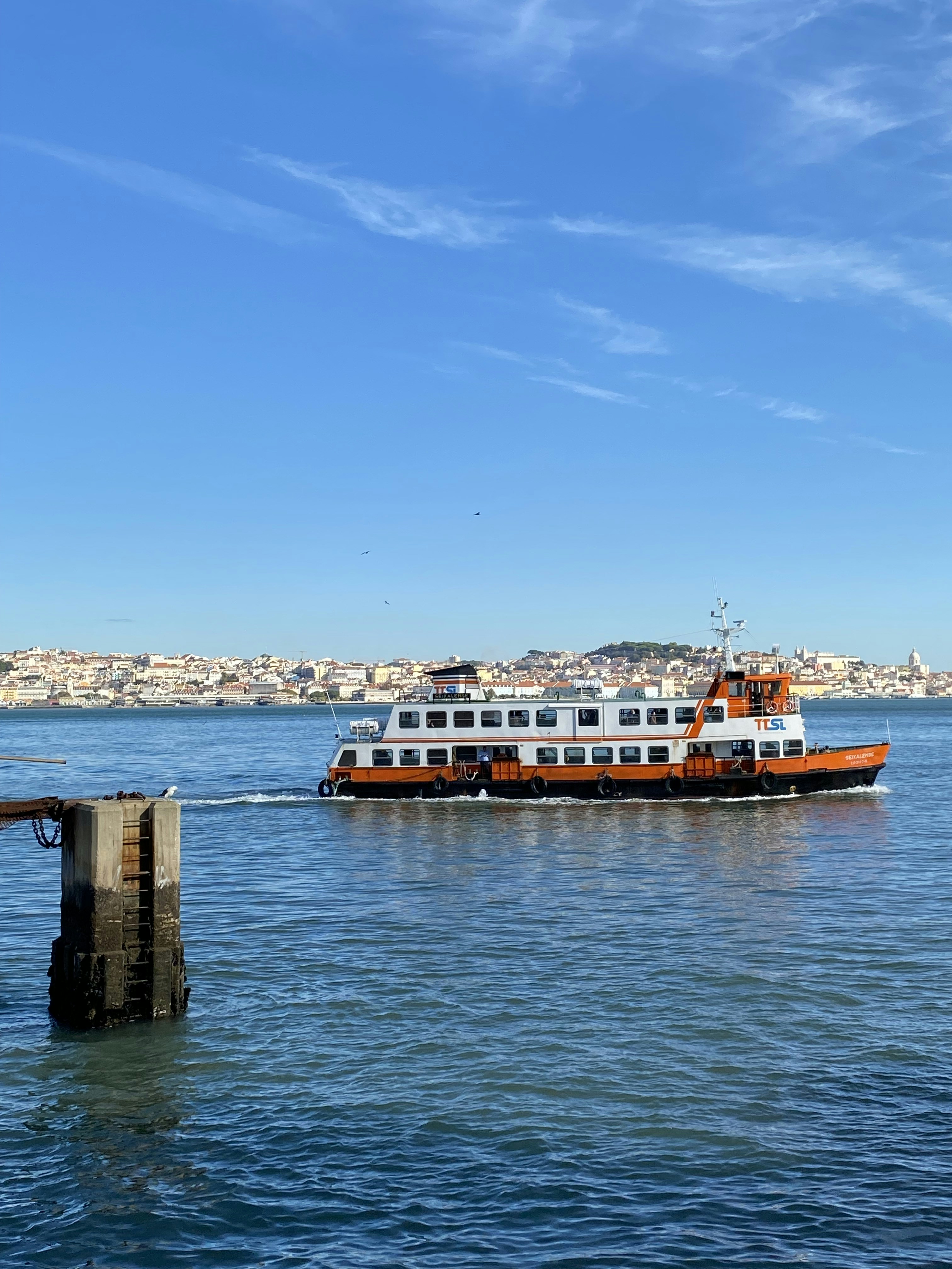 Orange Ferry Crossing the Tagus: A Quiet Moment with Lisbon's Waterfront