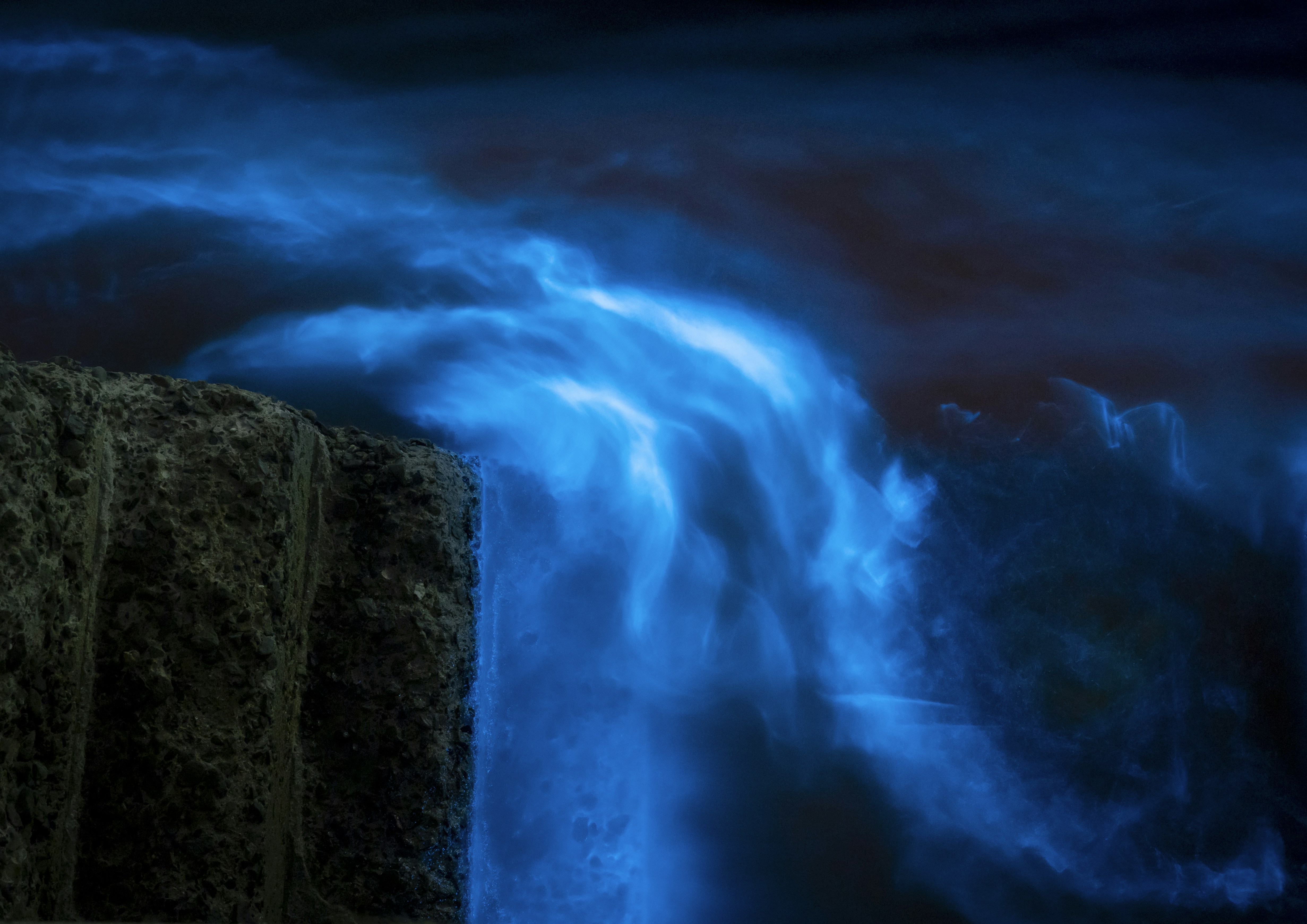 Neon Veil Over the Edge: A Cliffside Waterfall in Midnight Blue