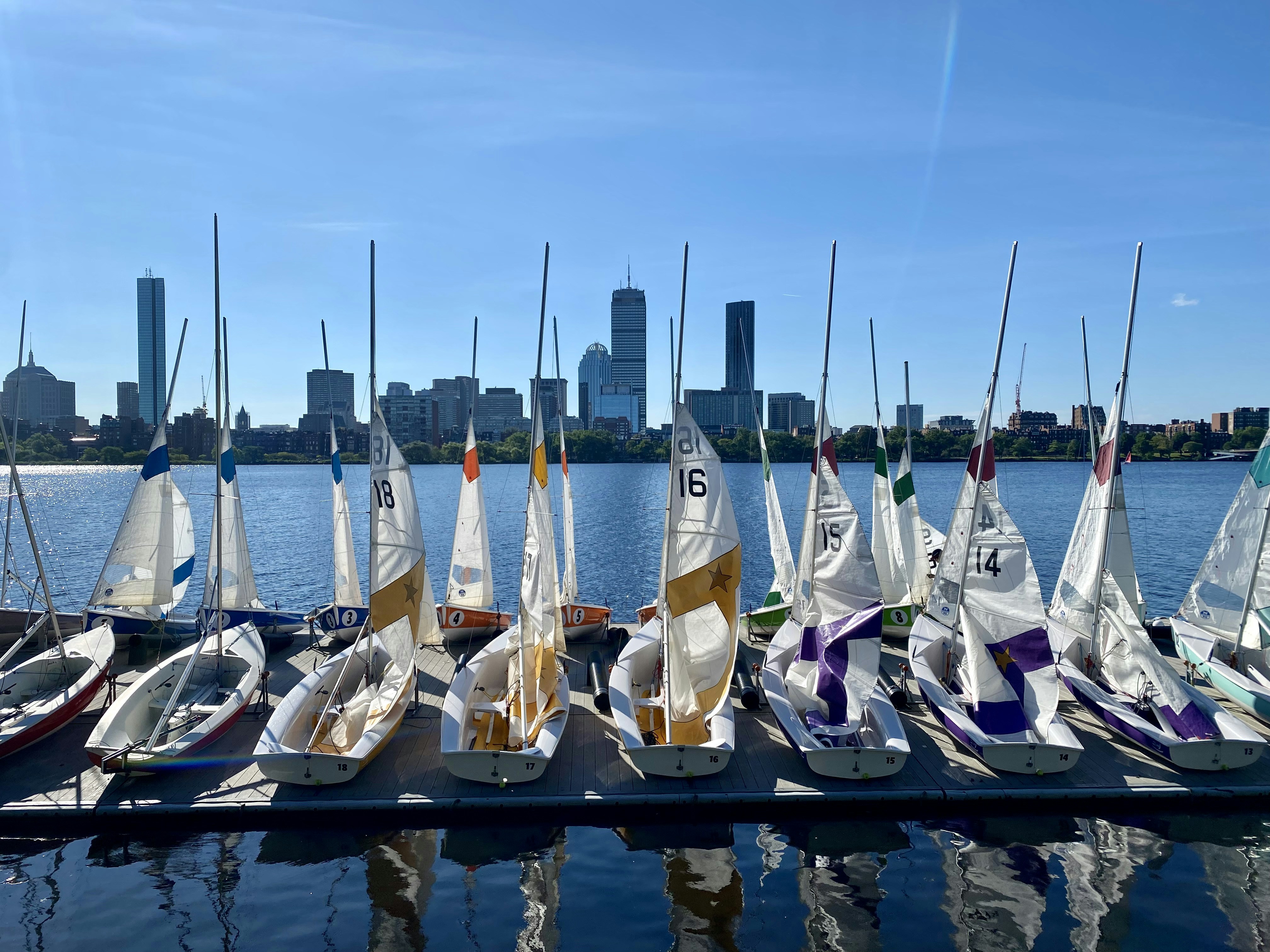 A row of sailboats sitting on top of a body of water photo – Free Ma ...