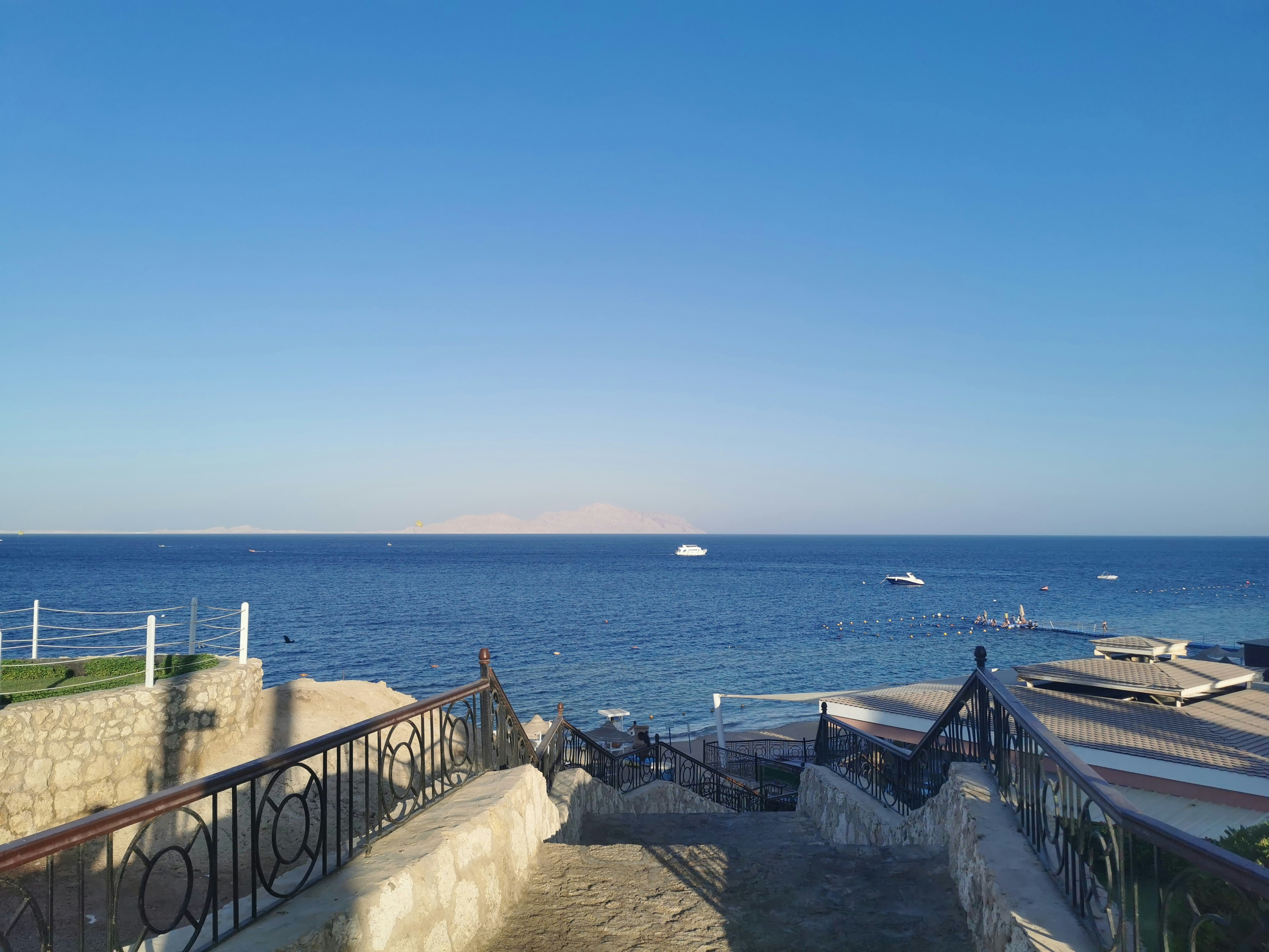a view of the ocean from the top of a hill