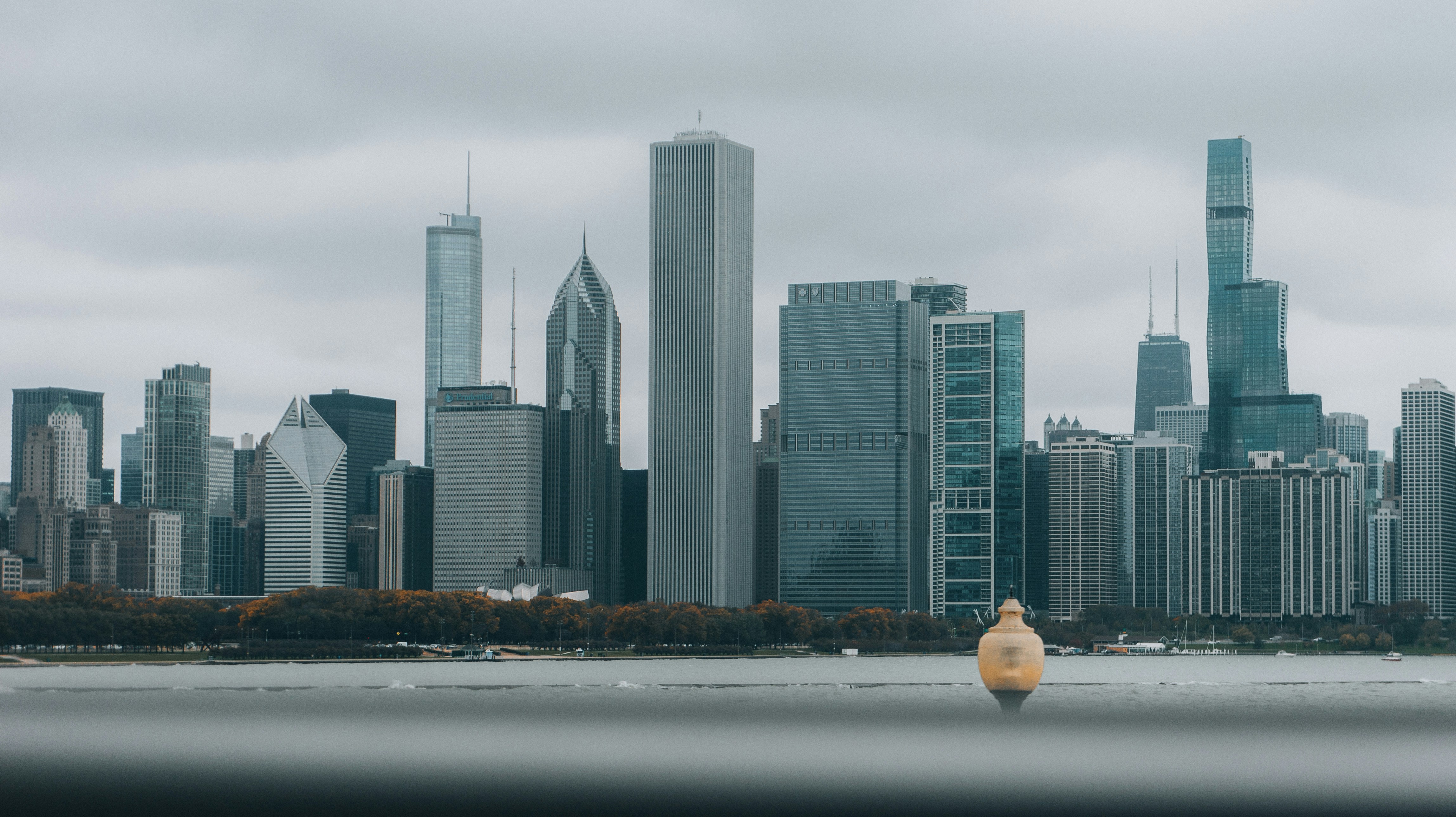 Harbor Sentinel: A Lone Buoy Before the Monochrome Skyline