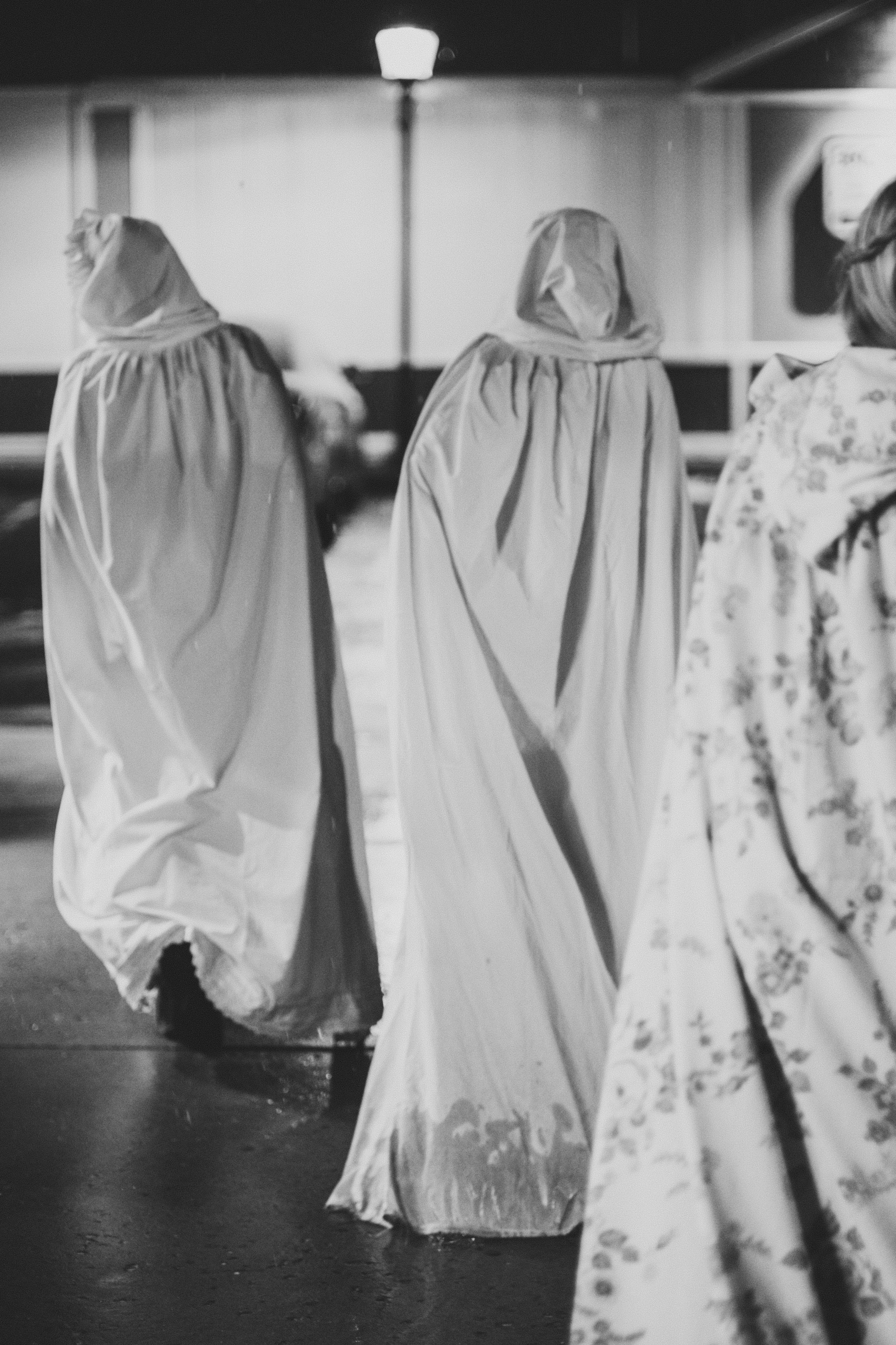 Three women in robes walking down a street photo – Free Night Image on ...