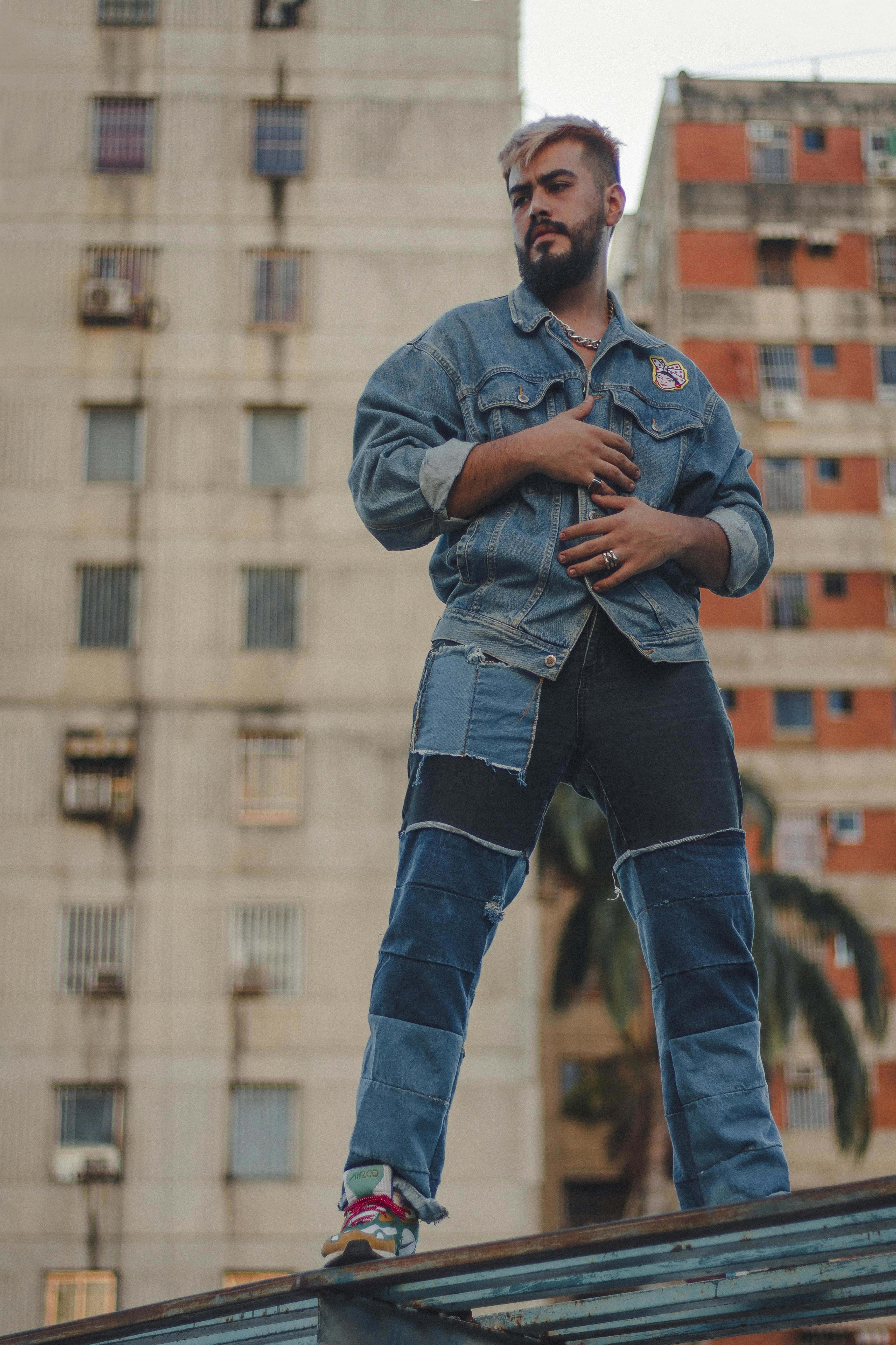 Patchwork Denim Stance Above the City Rooftops