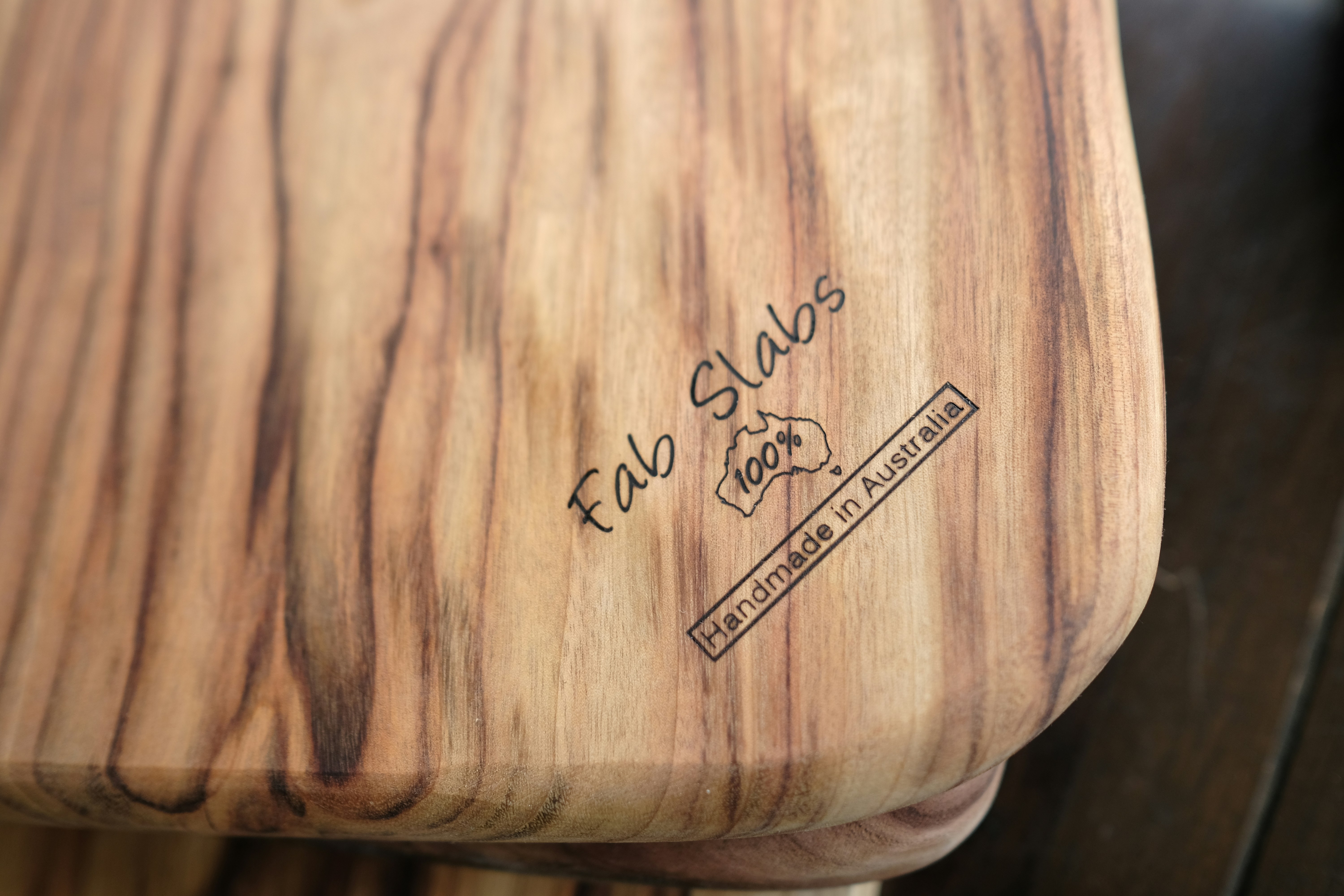 a close up of a wooden table with writing on it