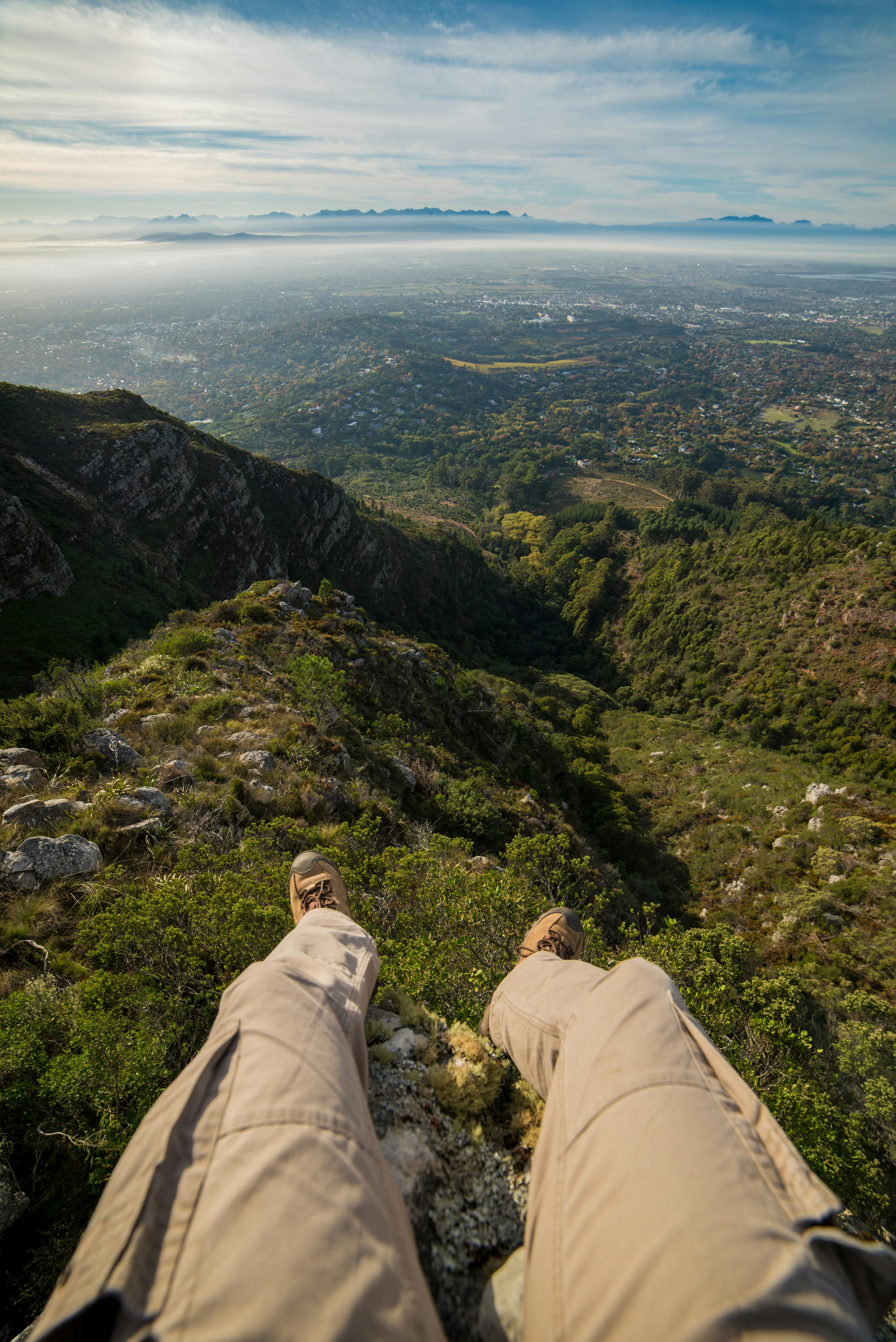 On the Edge: A Hiker's Panoramic Gaze from a Rocky Overlook