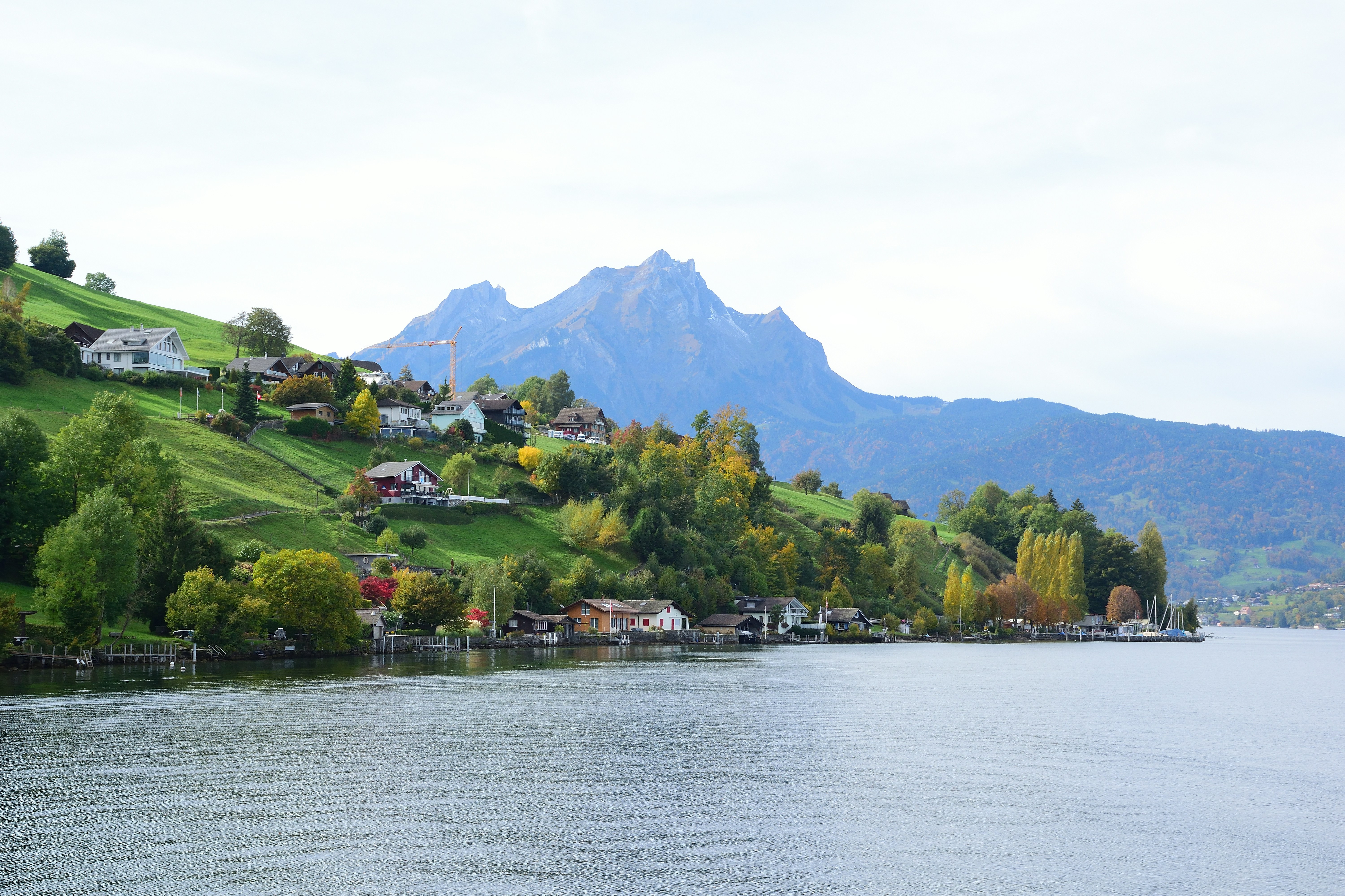 Alpine Village Crescent Along a Glassy Lake Under Jagged Peaks